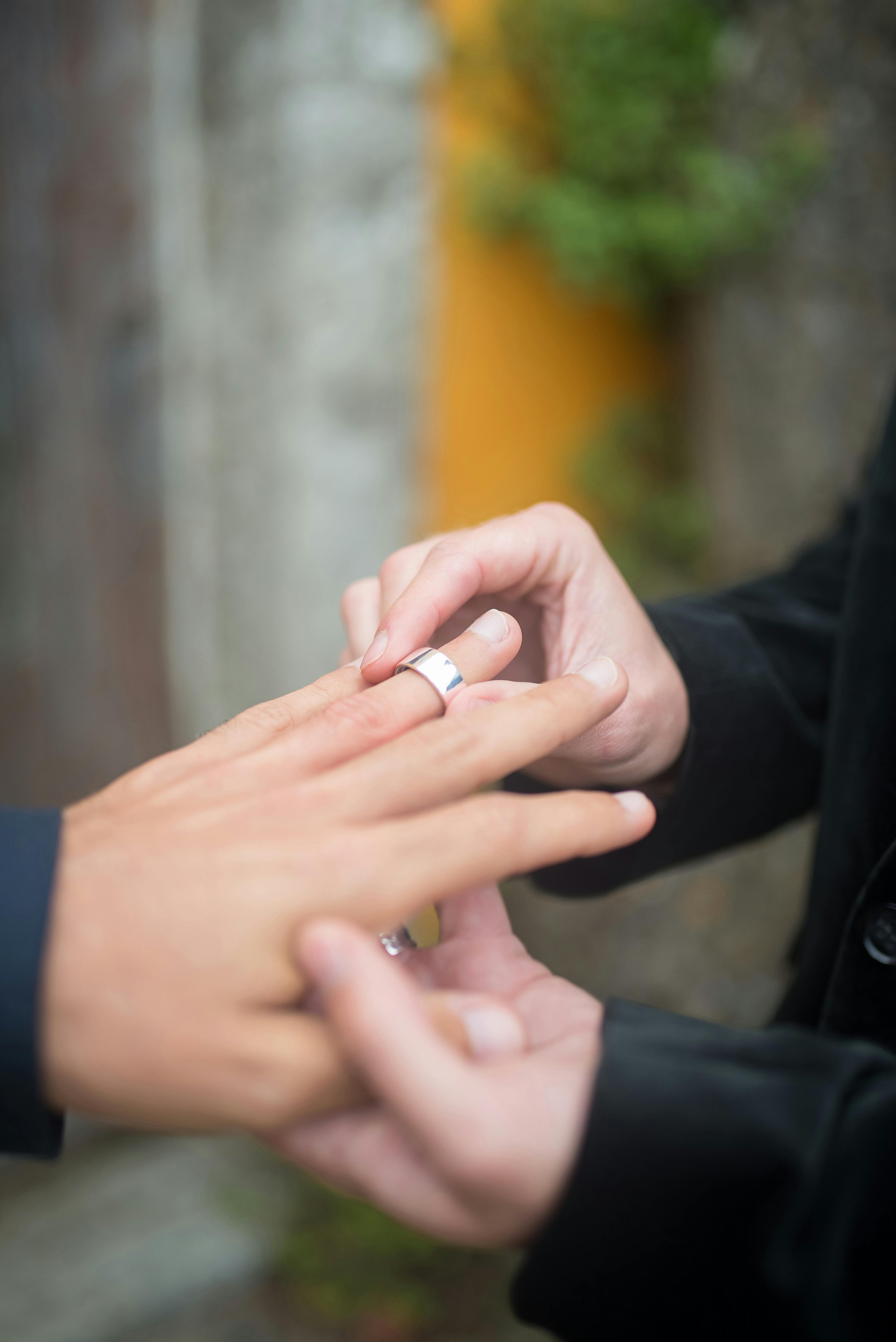 A Couple Putting On the Wedding Ring During the Ceremony · Free Stock Photo