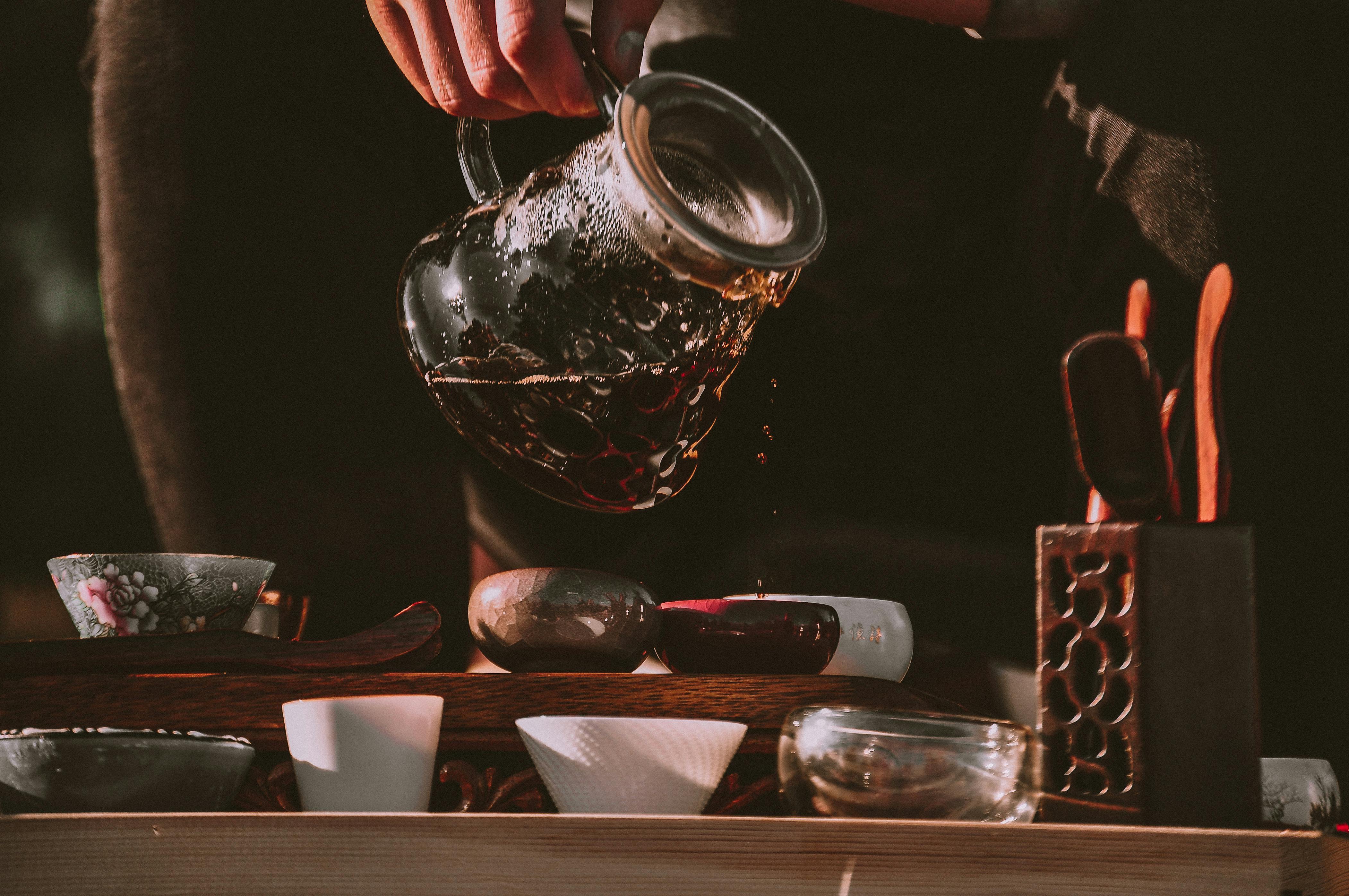 Person Pouring Brown Liquid in Ceramic Bowl · Free Stock Photo