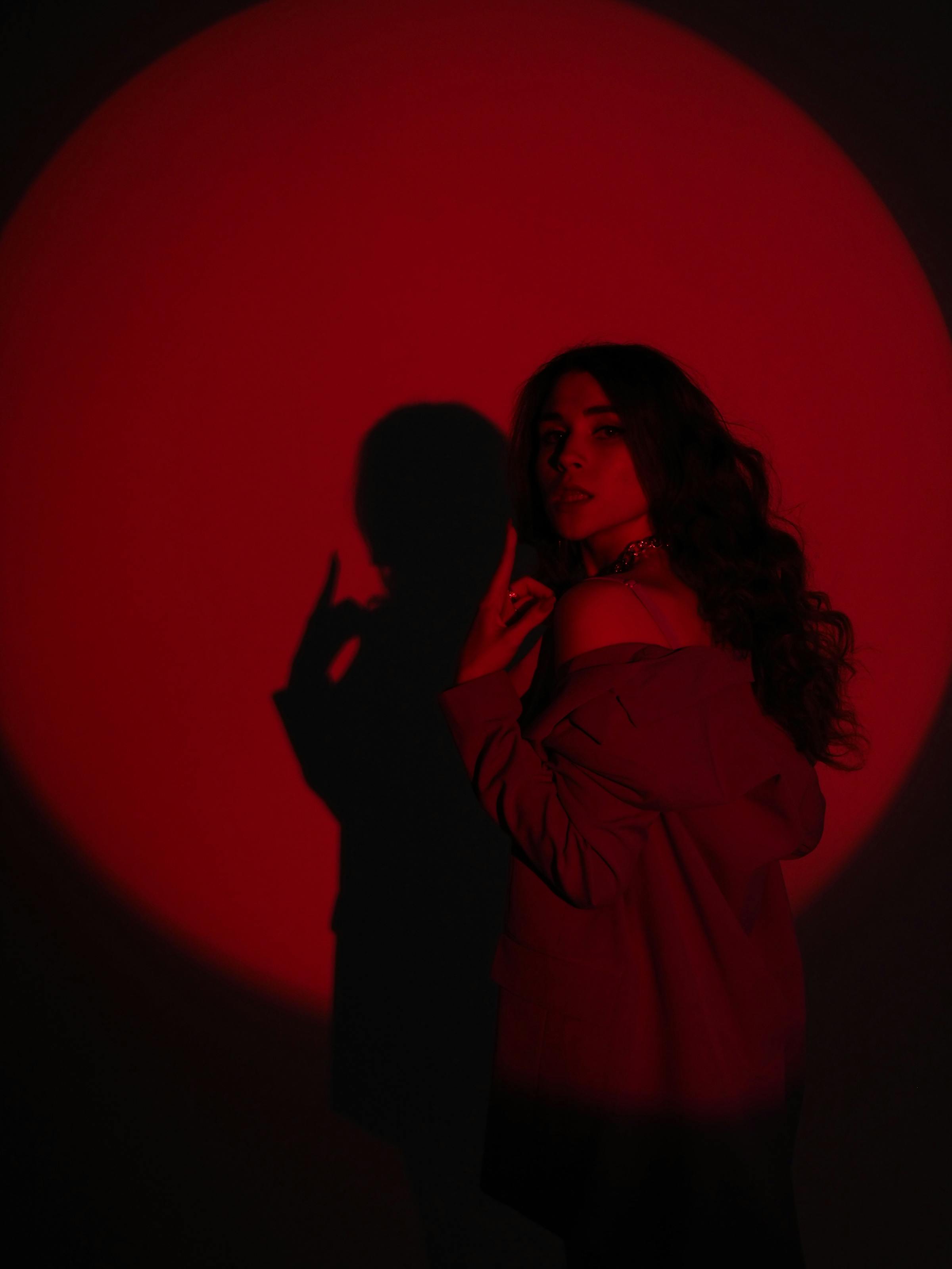 Portrait of a Woman on a Red Background · Free Stock Photo