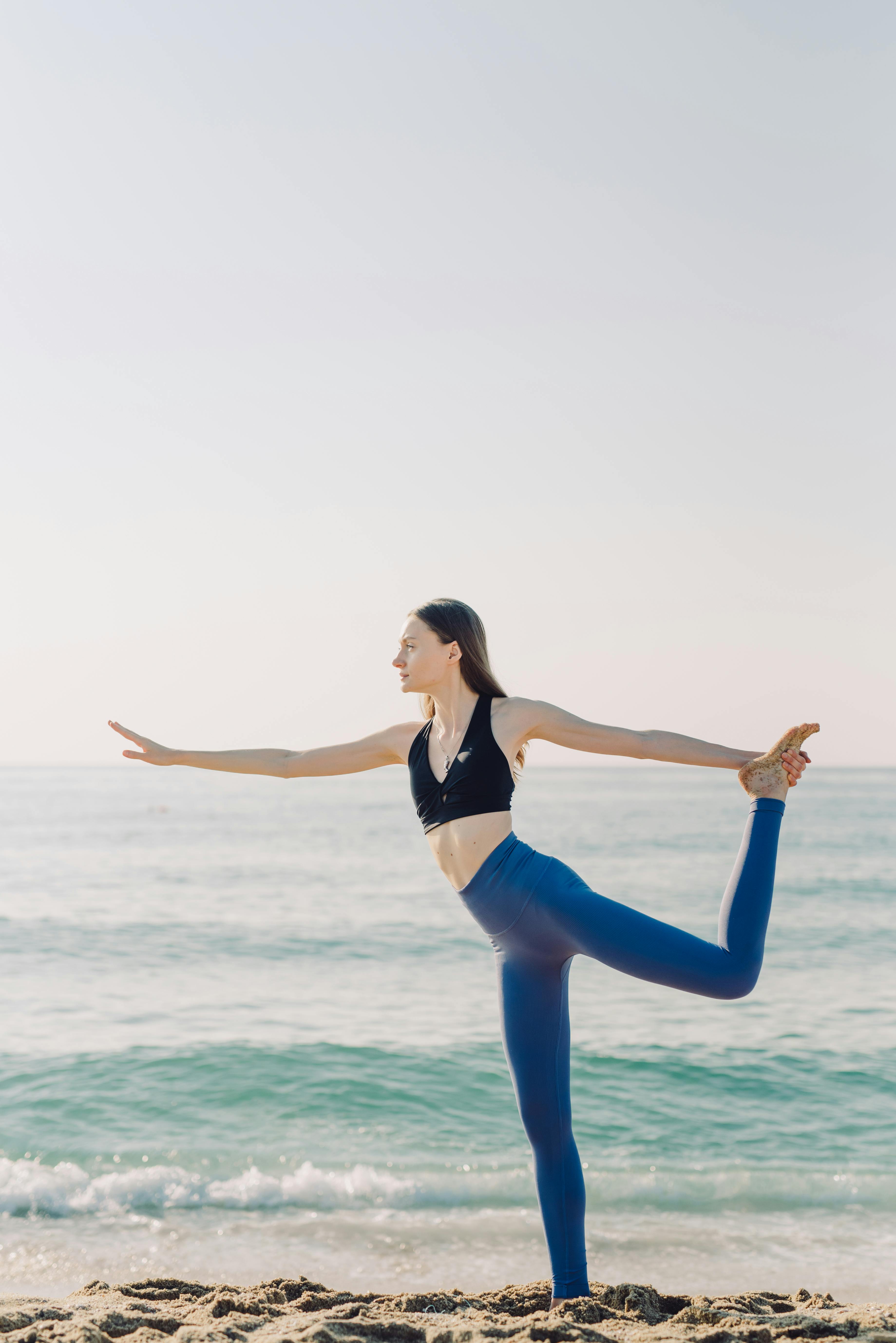 A Woman in Sportswear Doing a Standing Twist with Arms Raised on Side ...