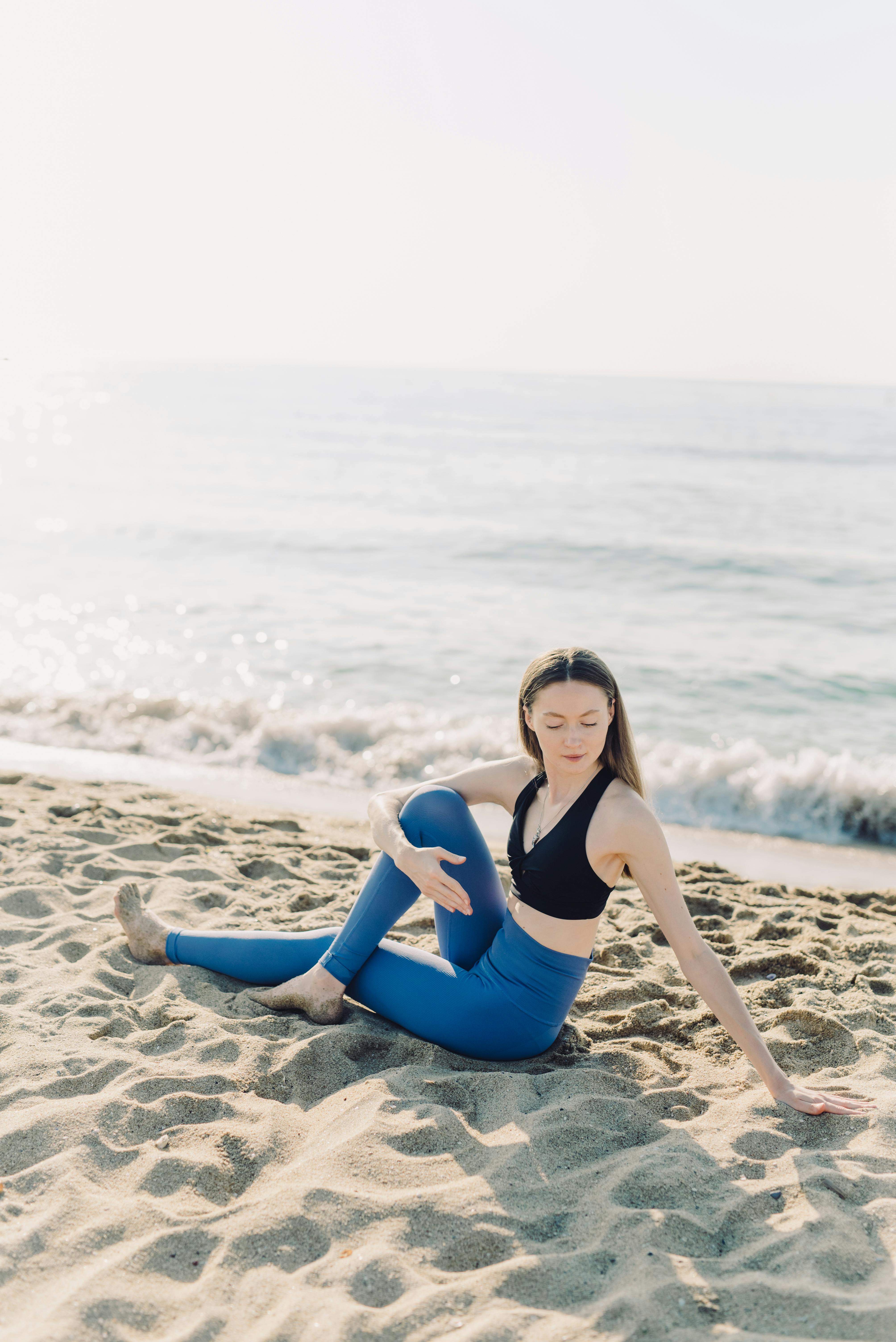 Woman Leaning Backward Near Body of Water · Free Stock Photo