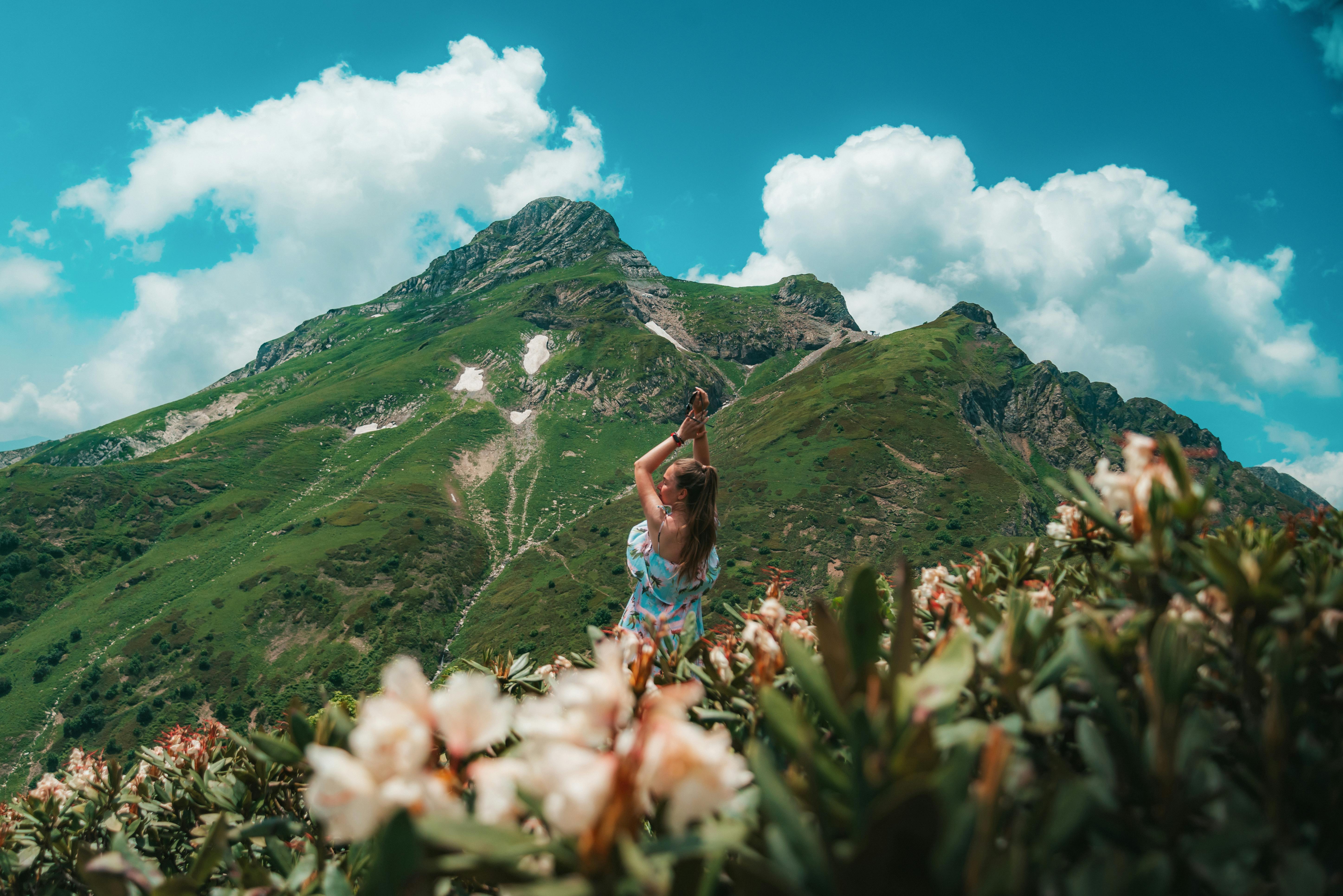 Back View of a Woman Raising Her Hands · Free Stock Photo