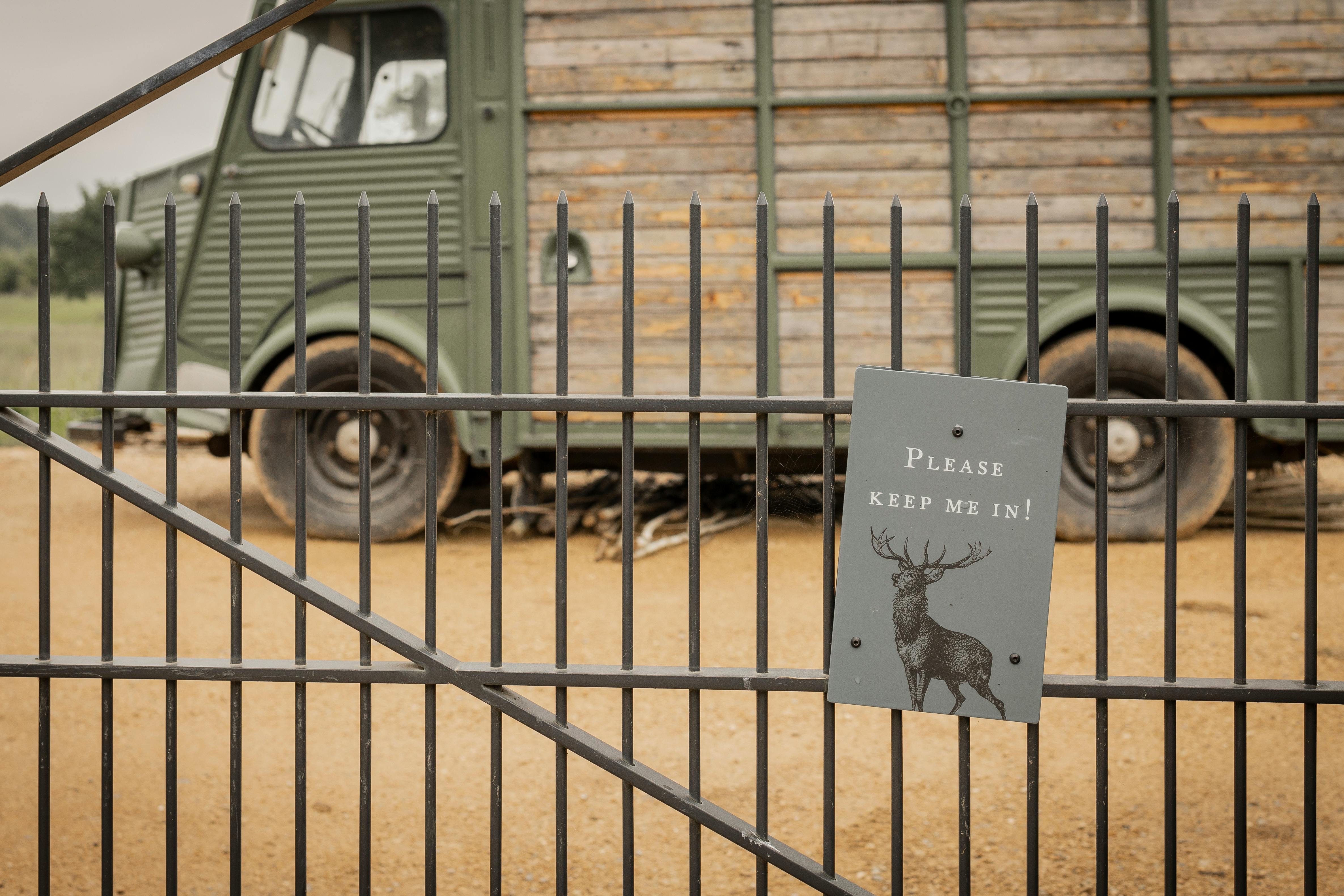 Sign Hanging on a Metal Fence · Free Stock Photo