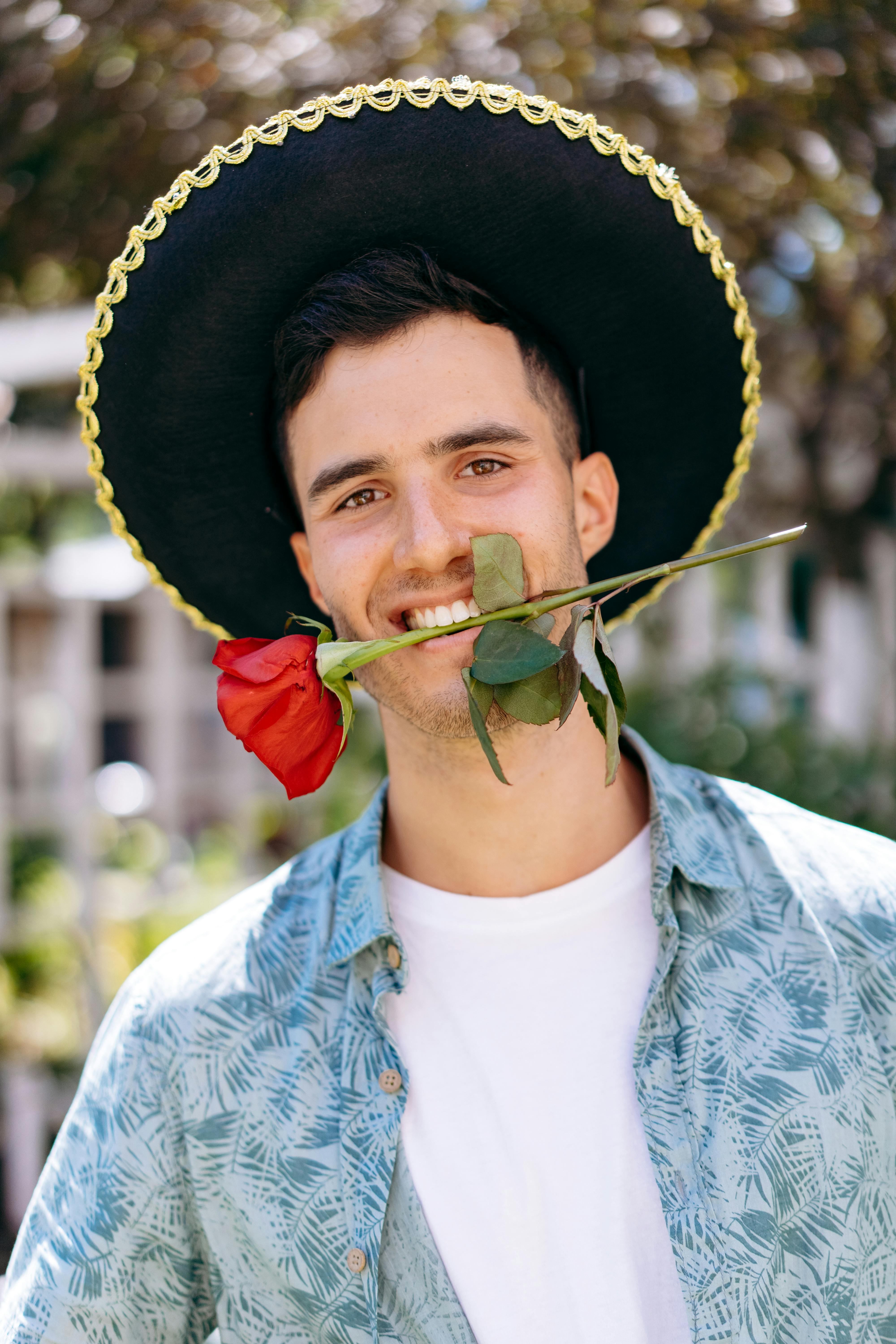 A Man Biting a Red Rose · Free Stock Photo