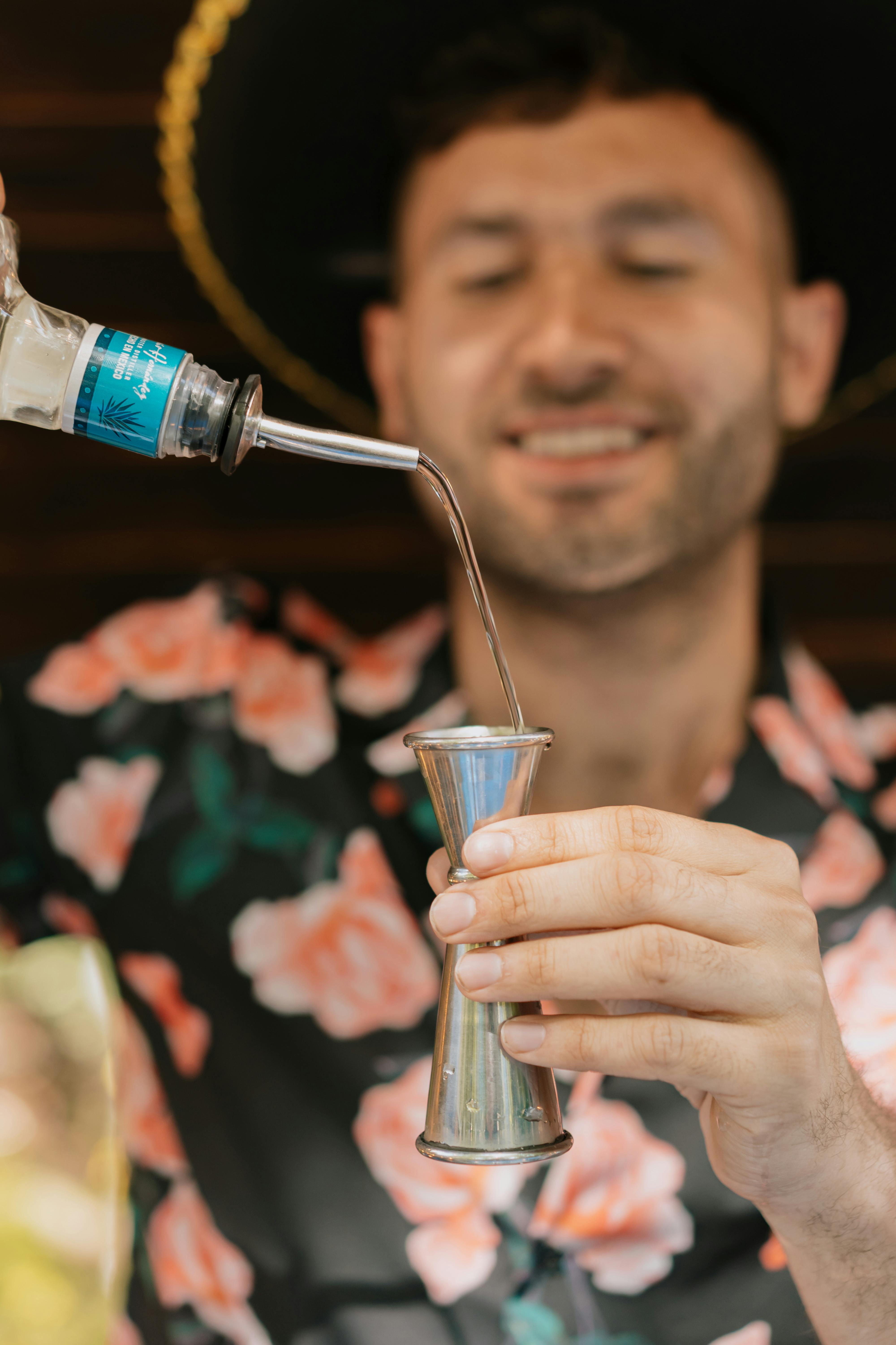 Bartender Pouring Vodka into a Jigger Measuring Cup · Free Stock Photo