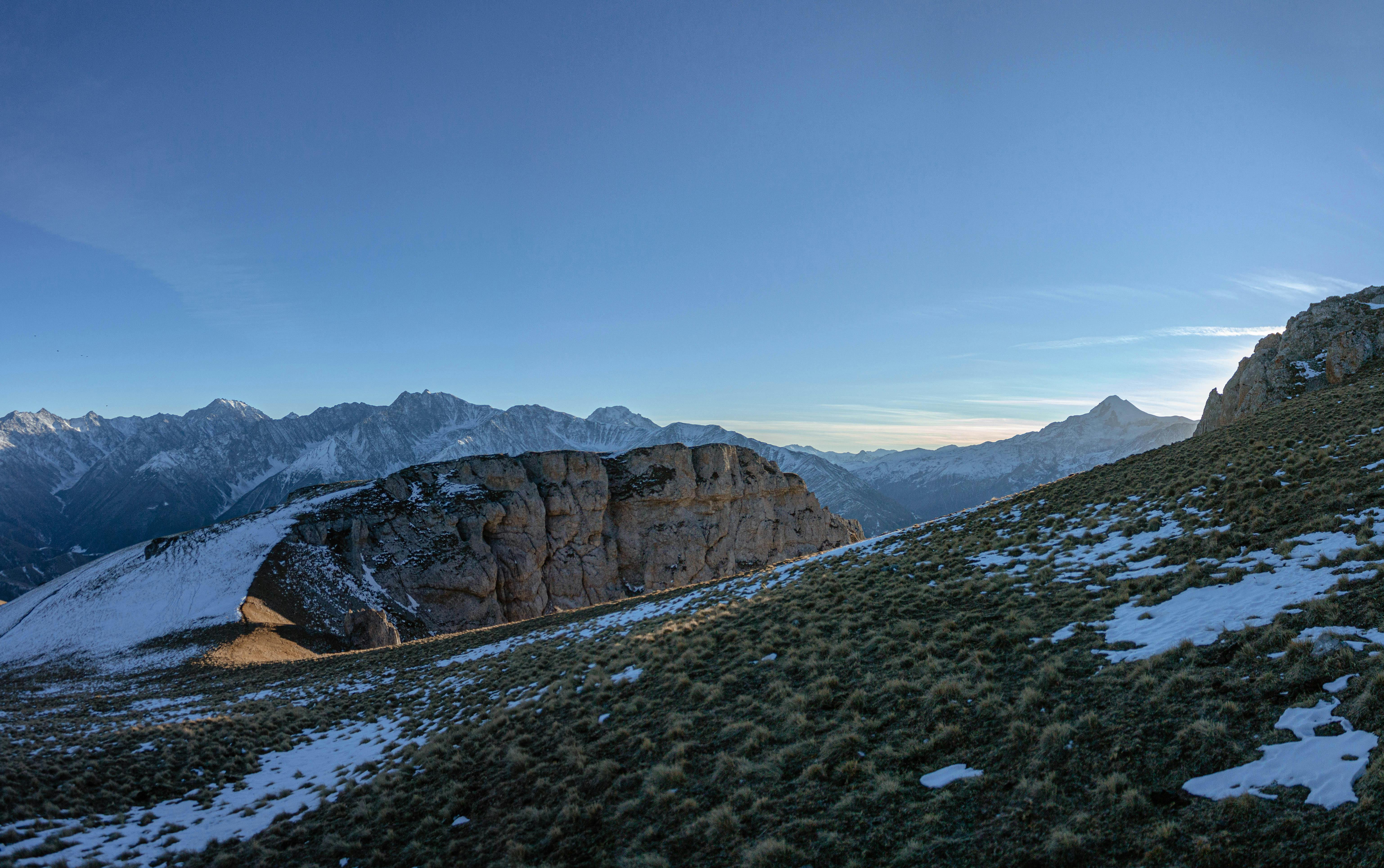 Landscape of Rocky Mountains Partly Covered in Snow · Free Stock Photo