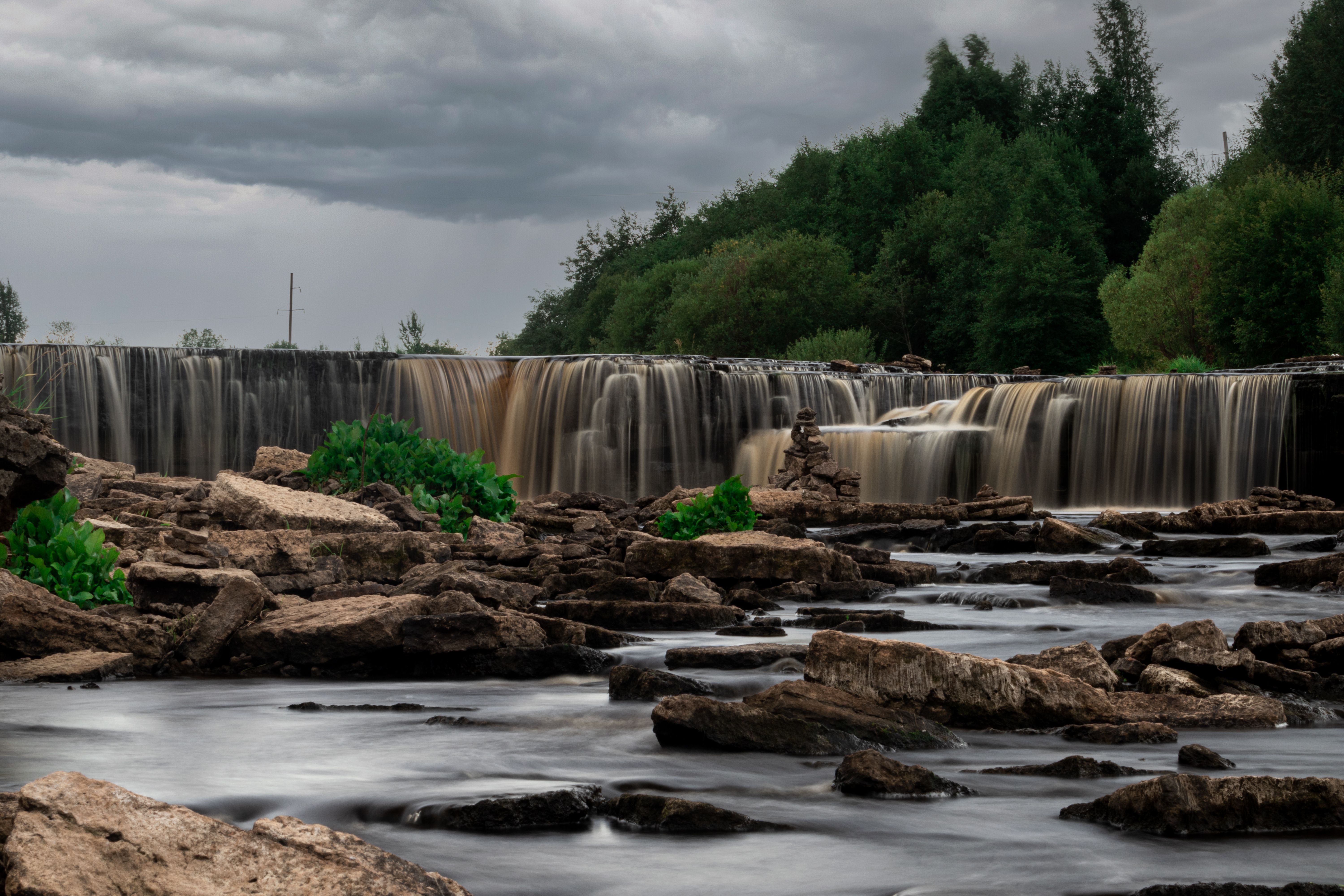 Waterfalls Near Green Trees Under Gloomy Sky · Free Stock Photo