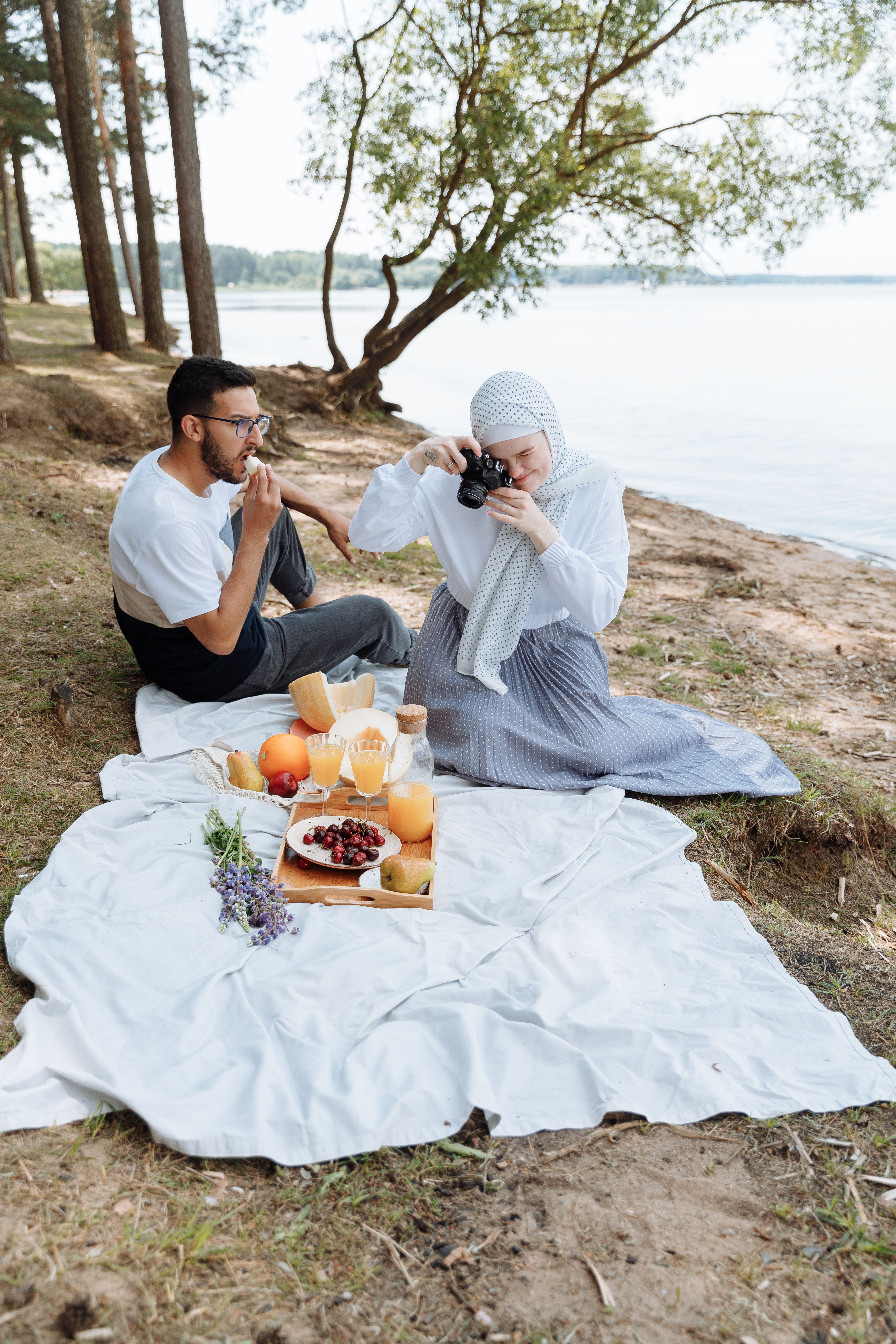 Woman in White Hijab Taking Picture of Fruits on Picnic Blanket · Free ...