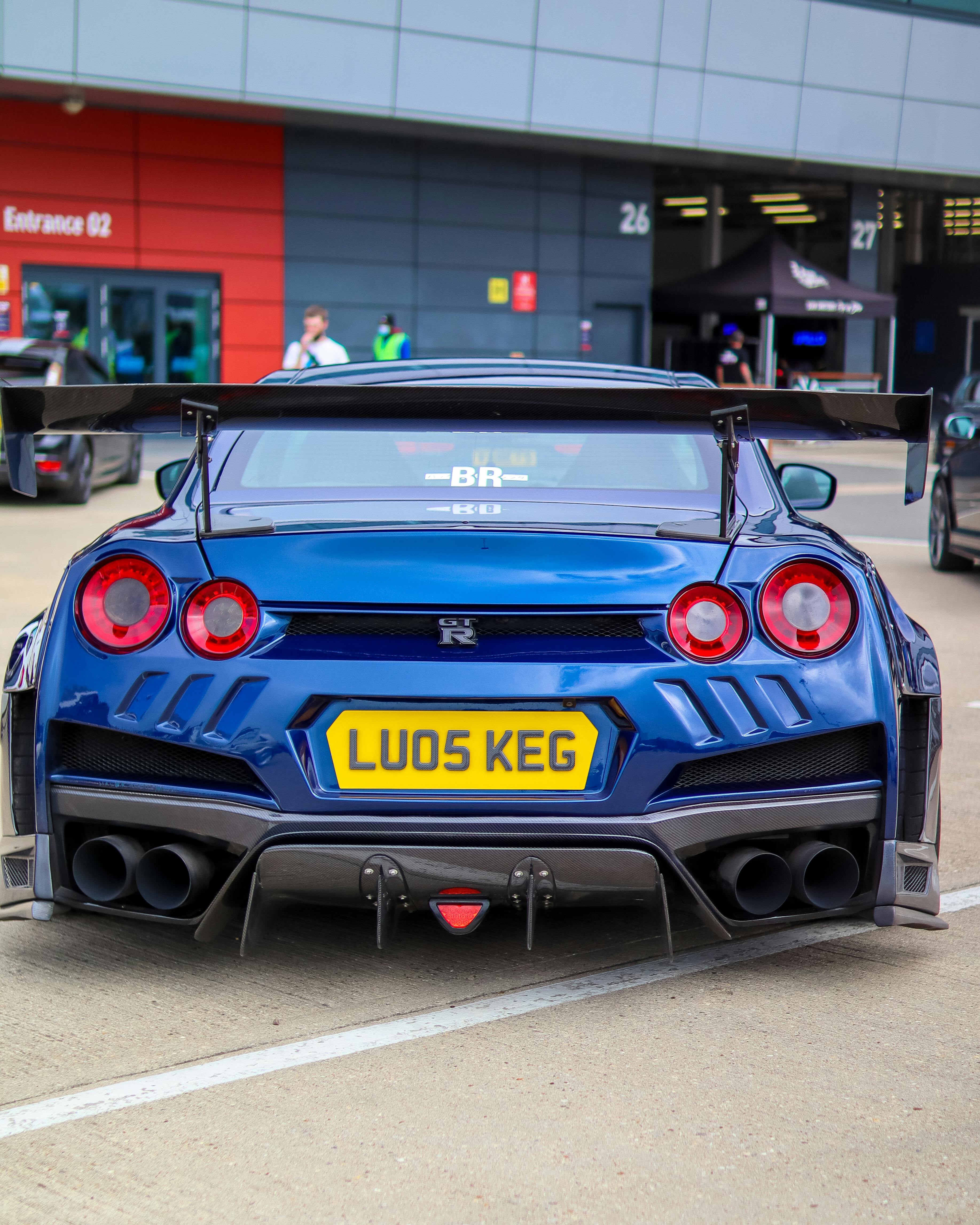 A Blue Sports Car Parked on the Road · Free Stock Photo