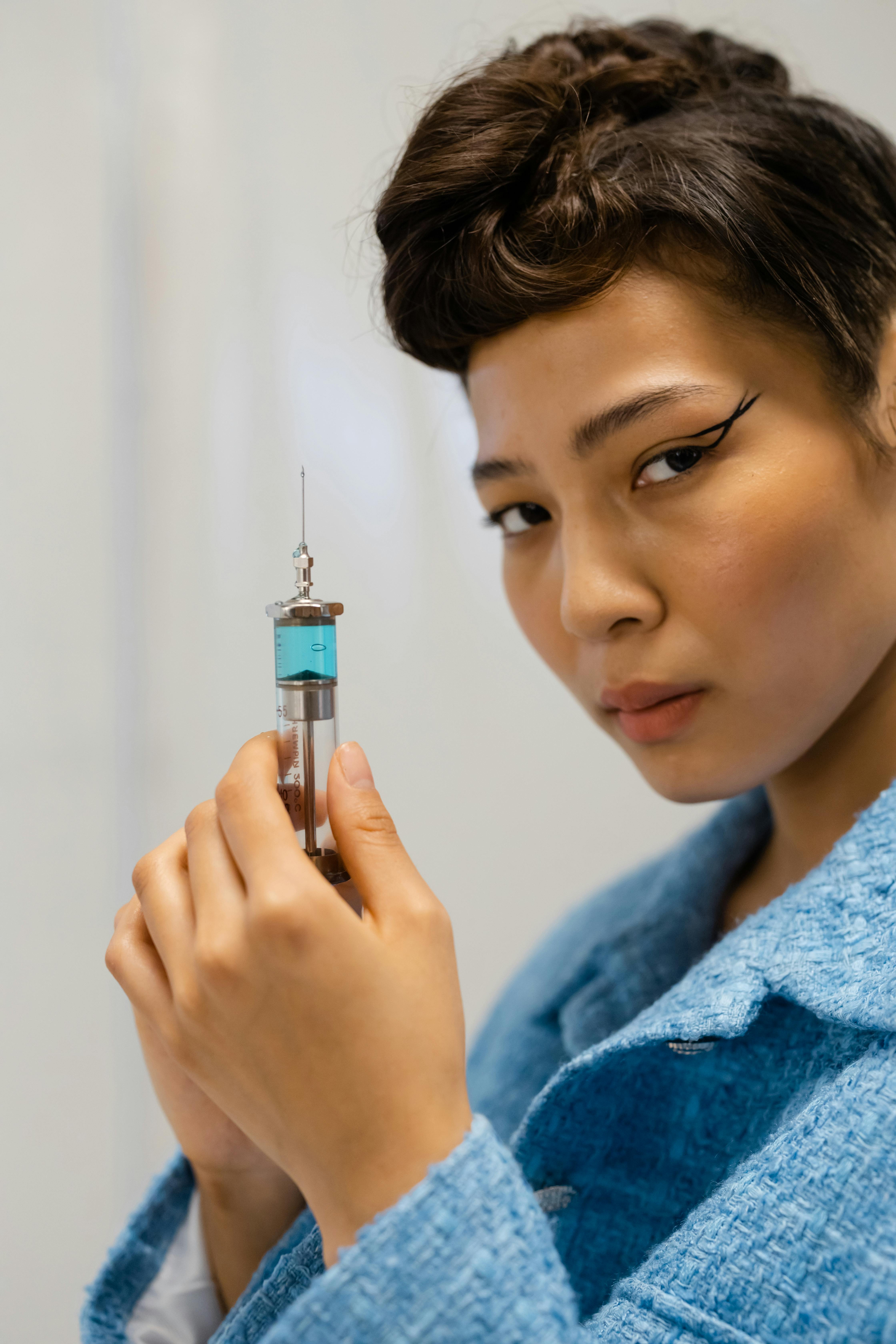 Man Getting Injected with Blue Liquid · Free Stock Photo