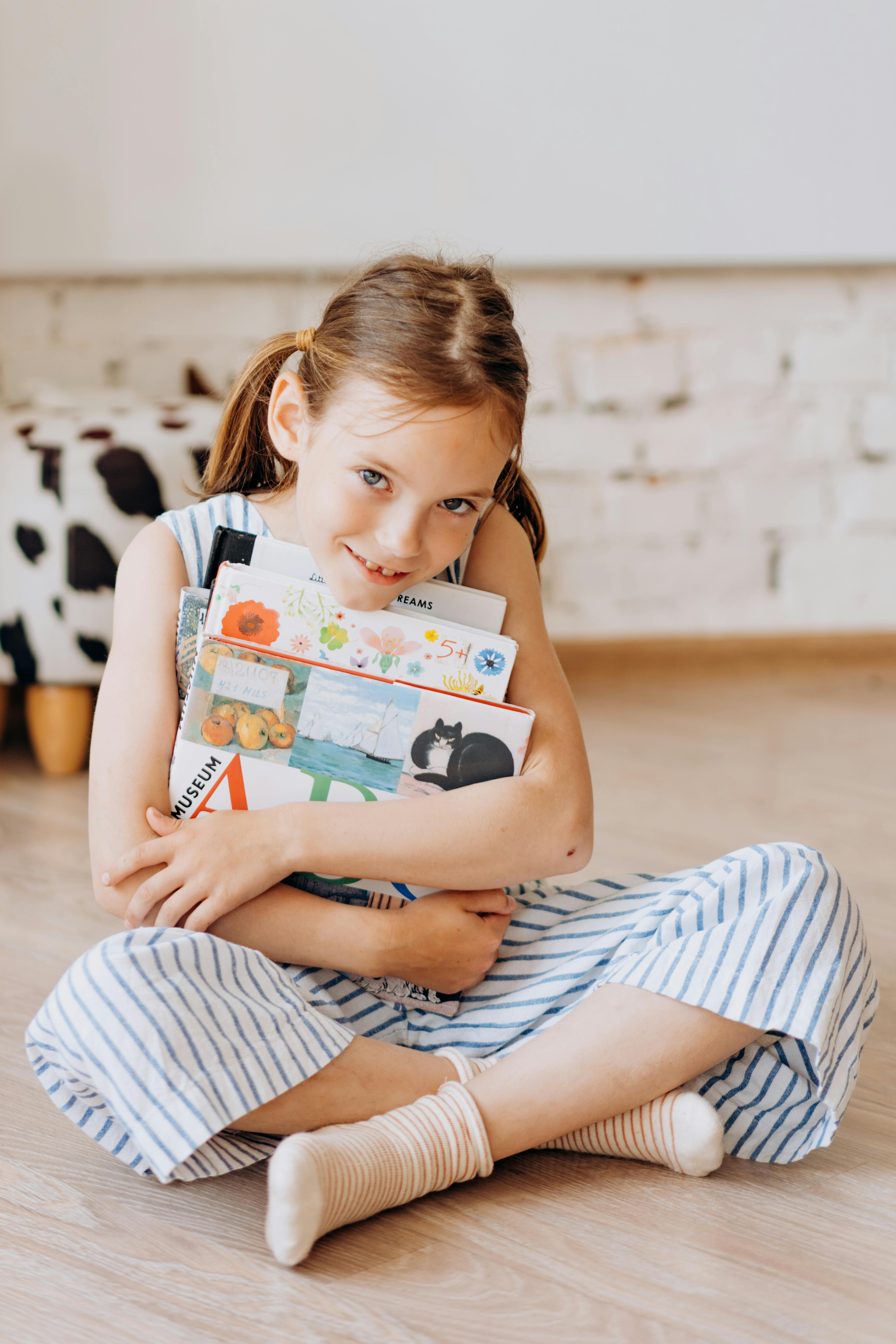 A Girl Hugging Books · Free Stock Photo