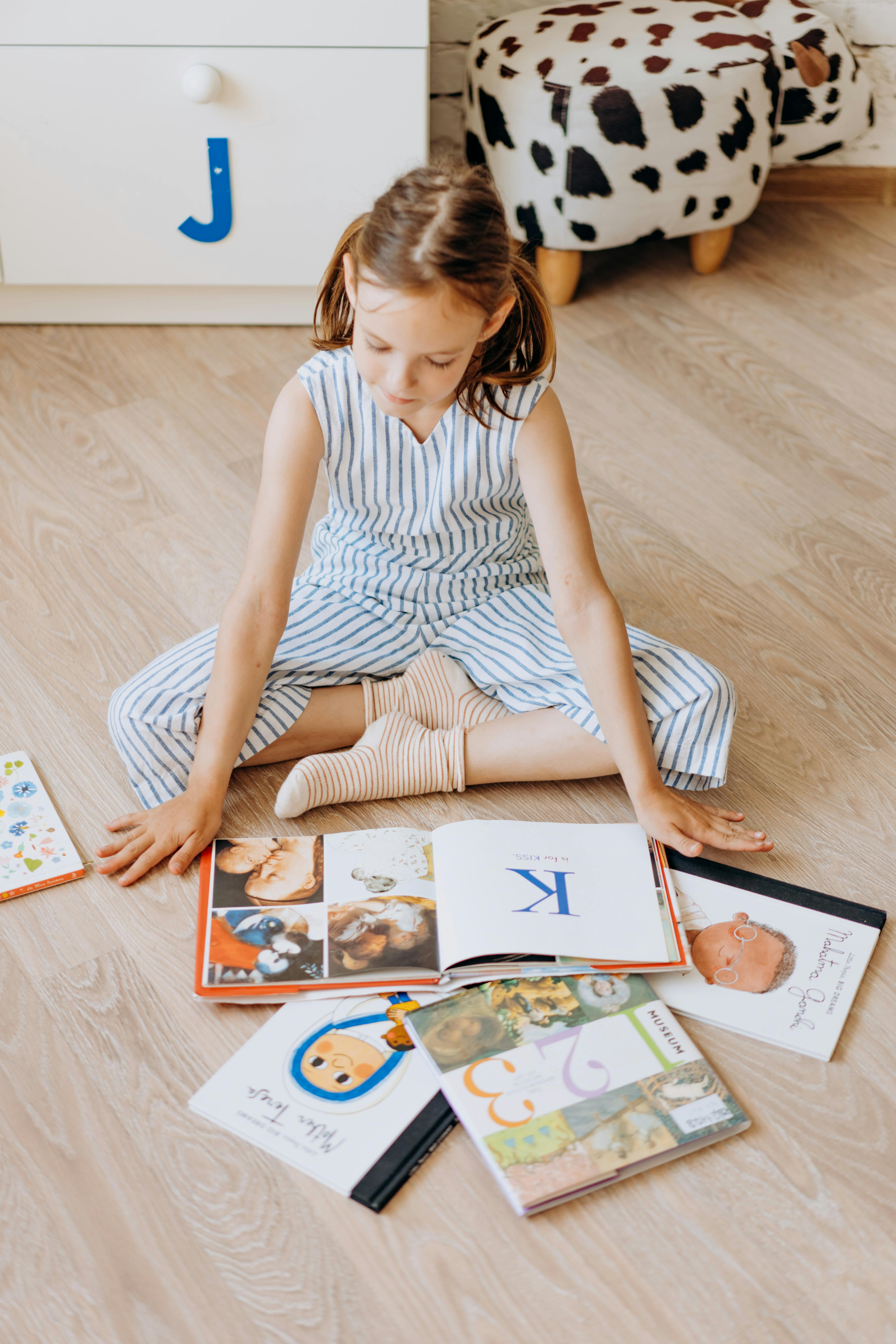 A Girl Looking at an Alphabet Book · Free Stock Photo