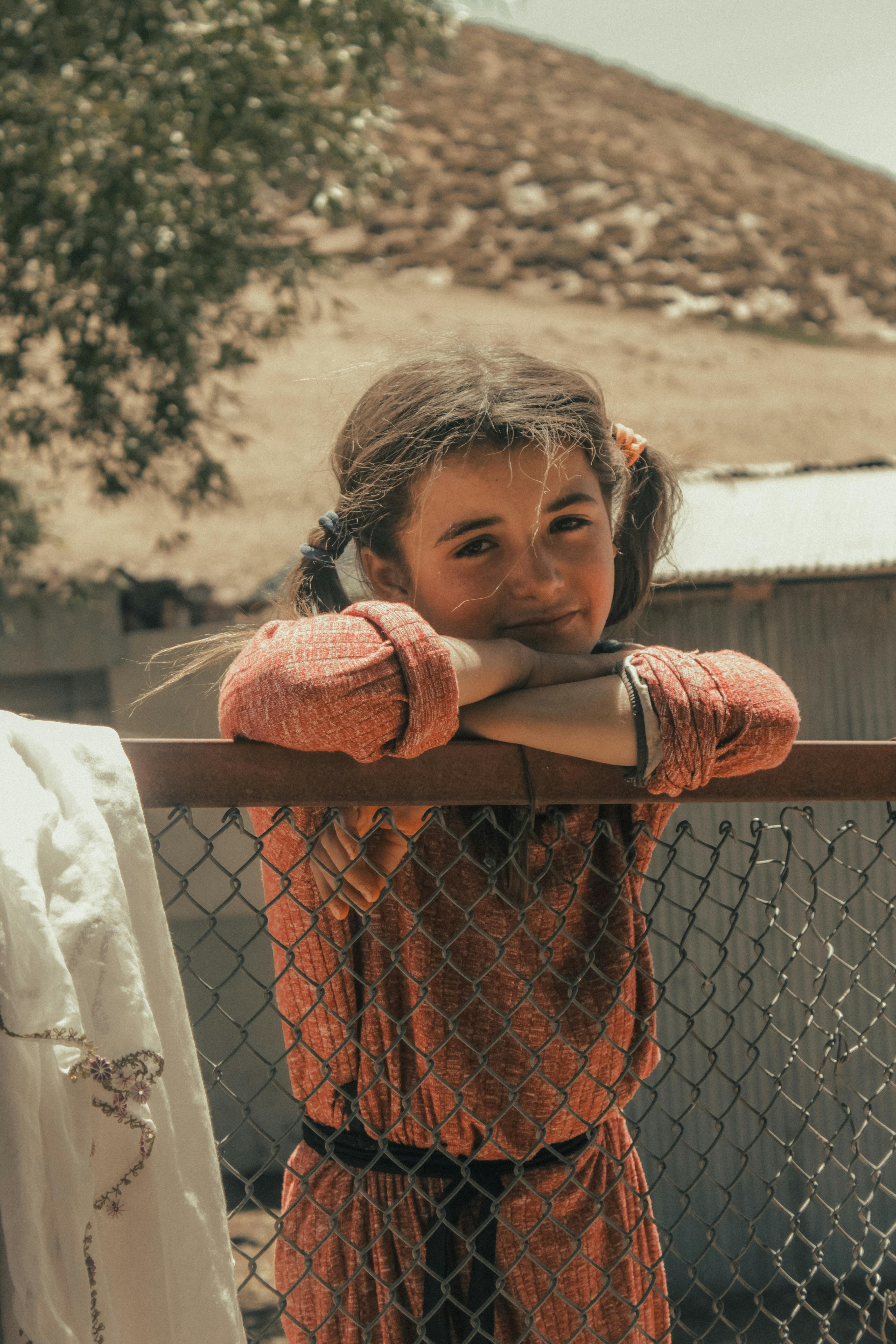 Kids Behind a Chain Link Fence · Free Stock Photo