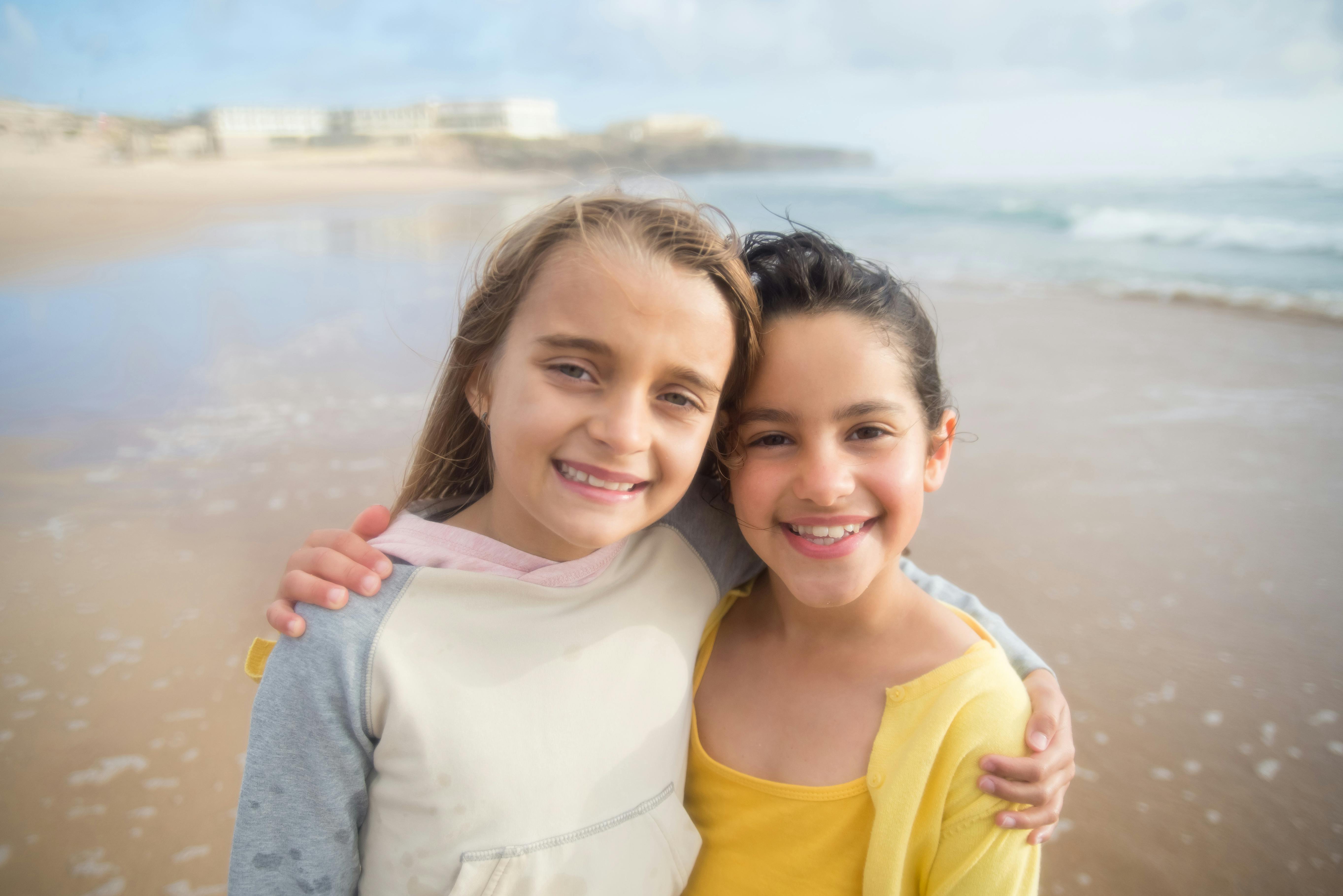 Young Girls Hugging on the Beach · Free Stock Photo