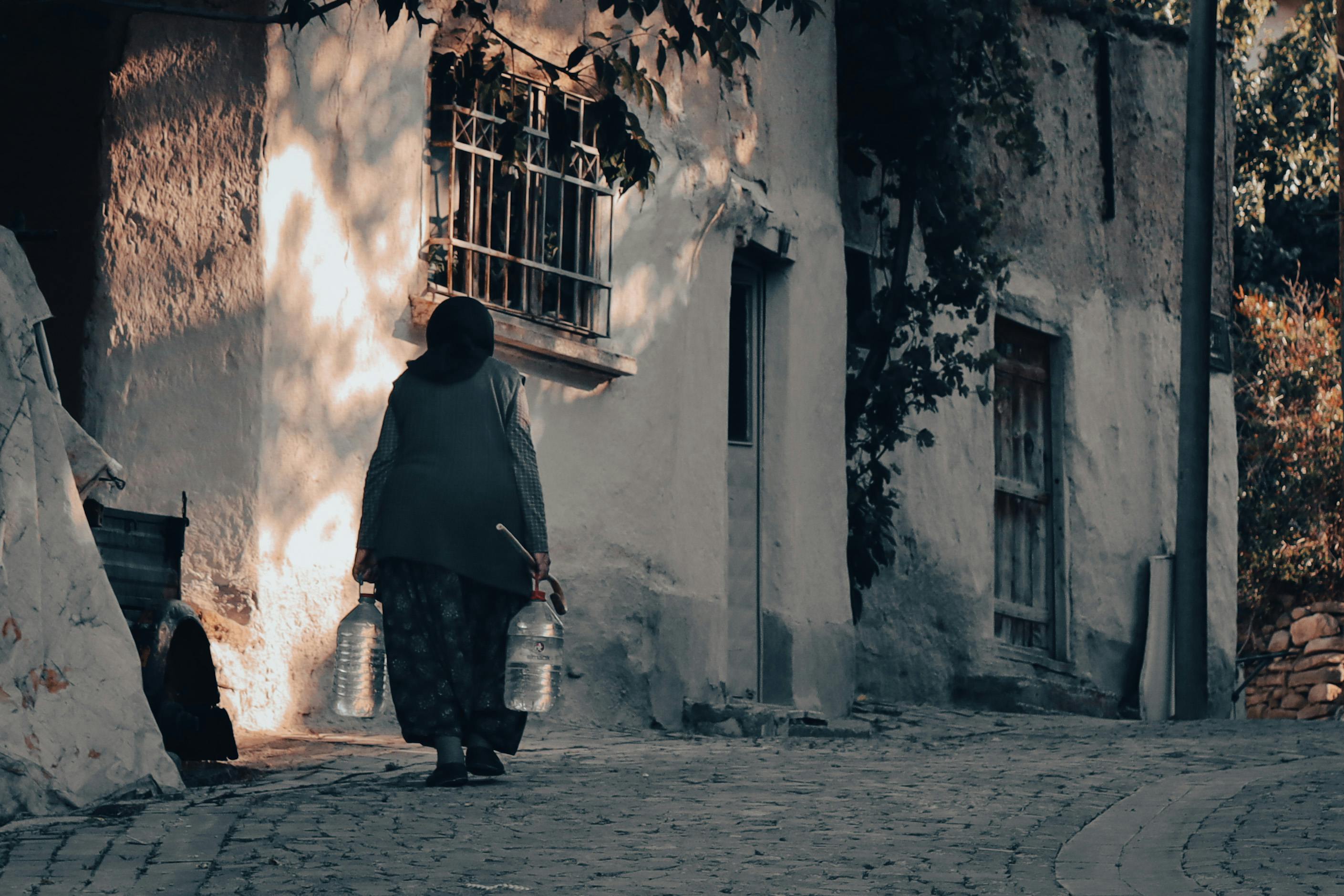 A Man Carrying Milk Jars · Free Stock Photo