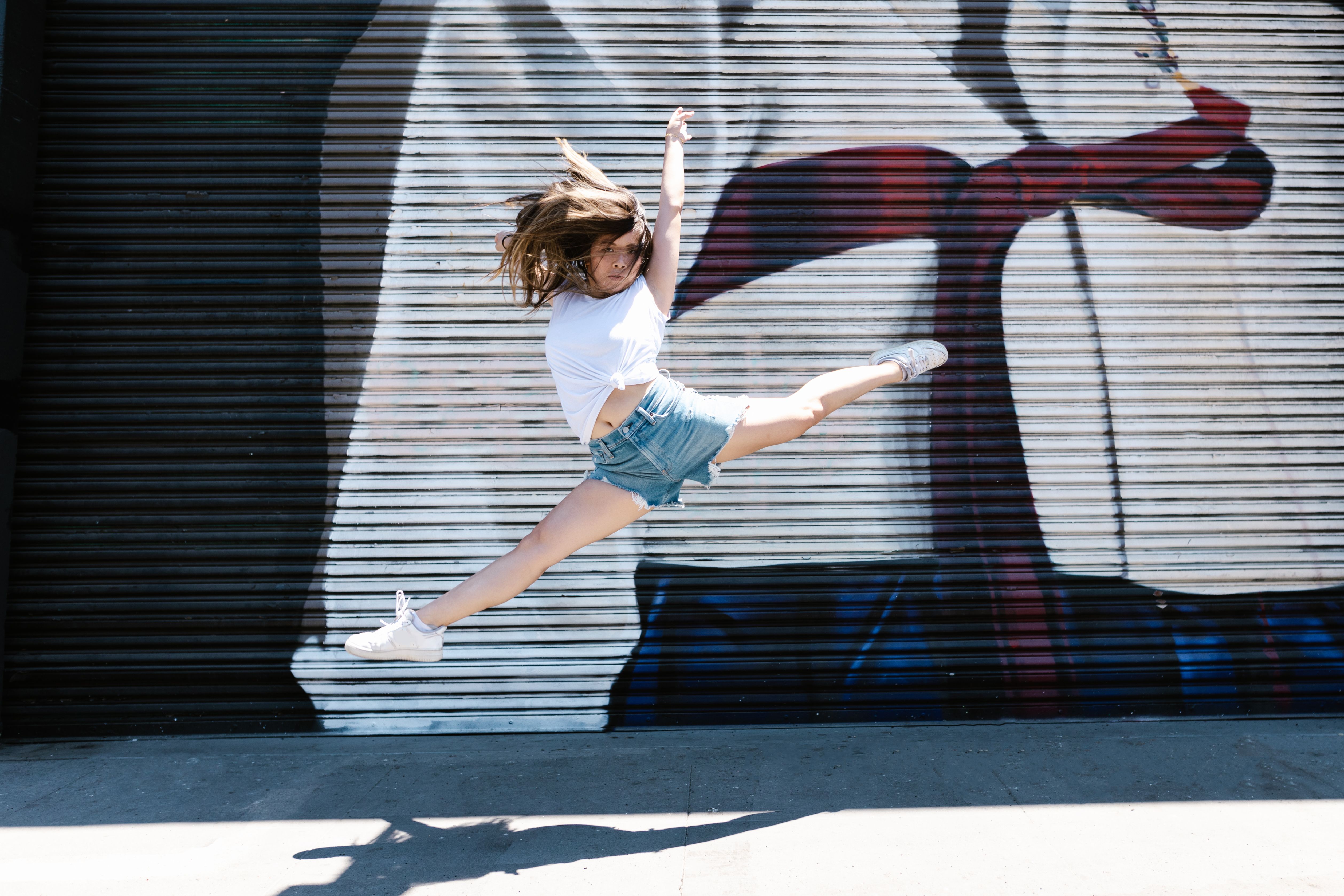 A Woman Jumping with Spread Legs · Free Stock Photo
