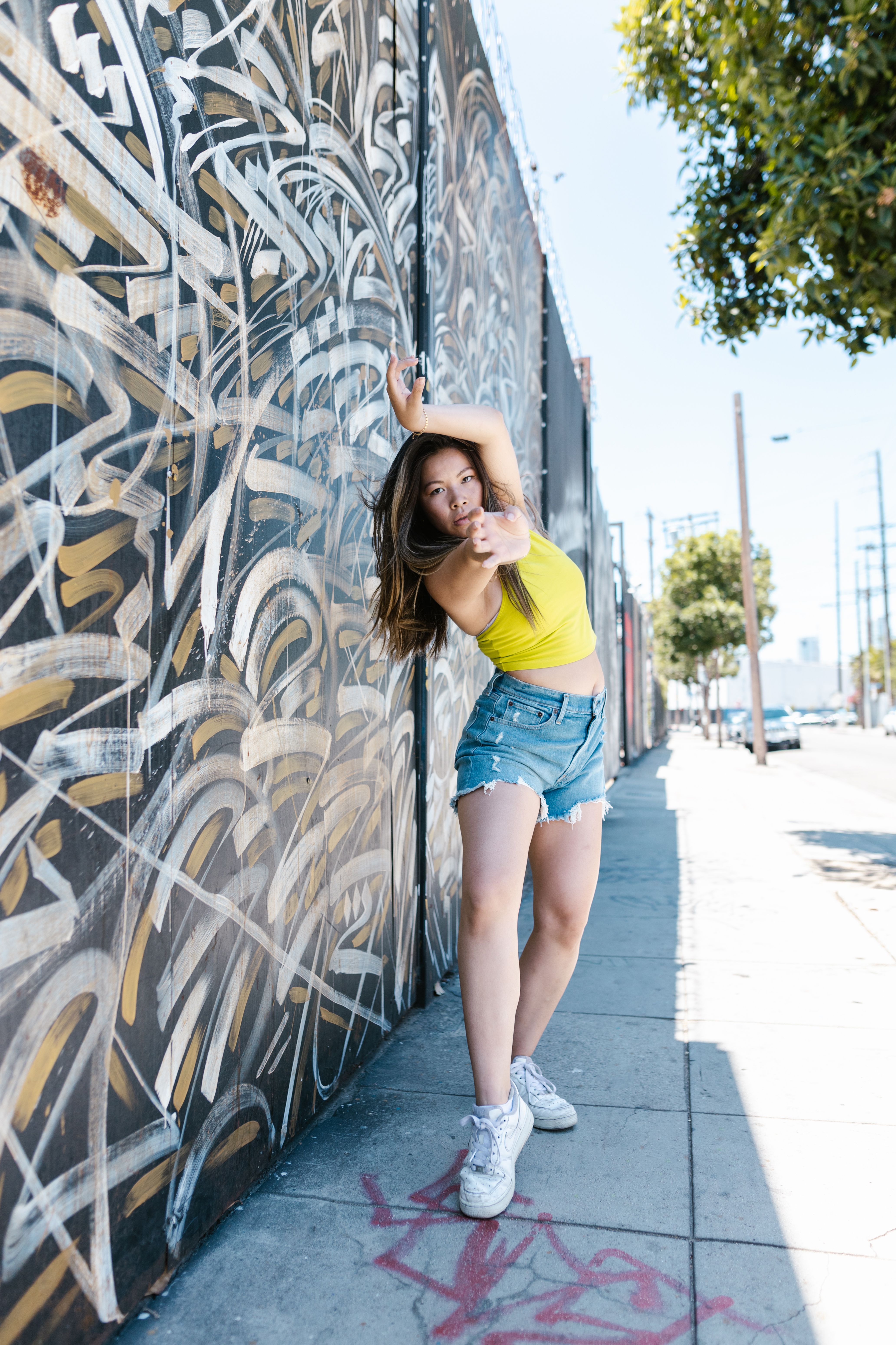 A Woman in Yellow Tank Top Dancing on the Street · Free Stock Photo