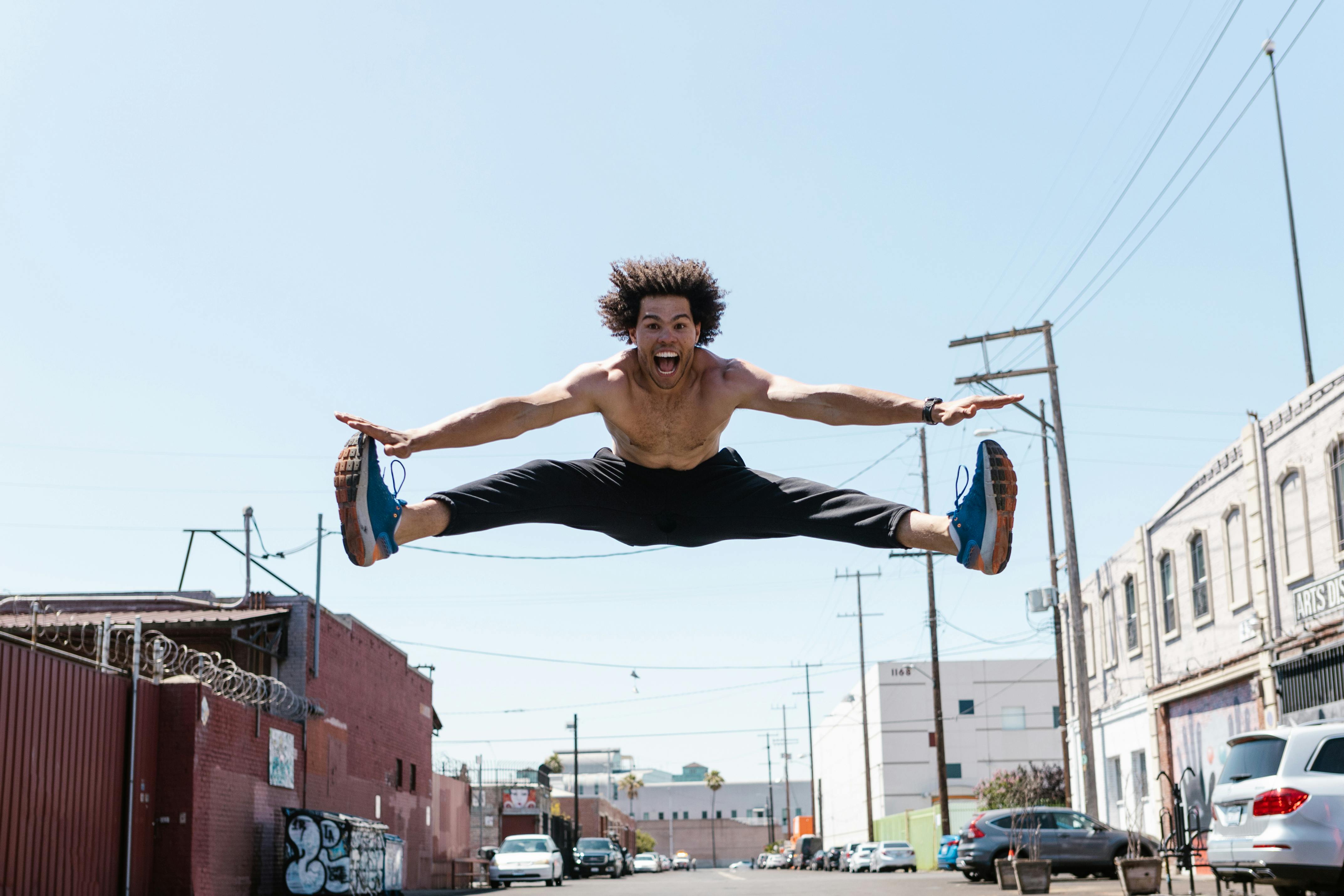 A Pair of Men in Sportswear Jumping · Free Stock Photo