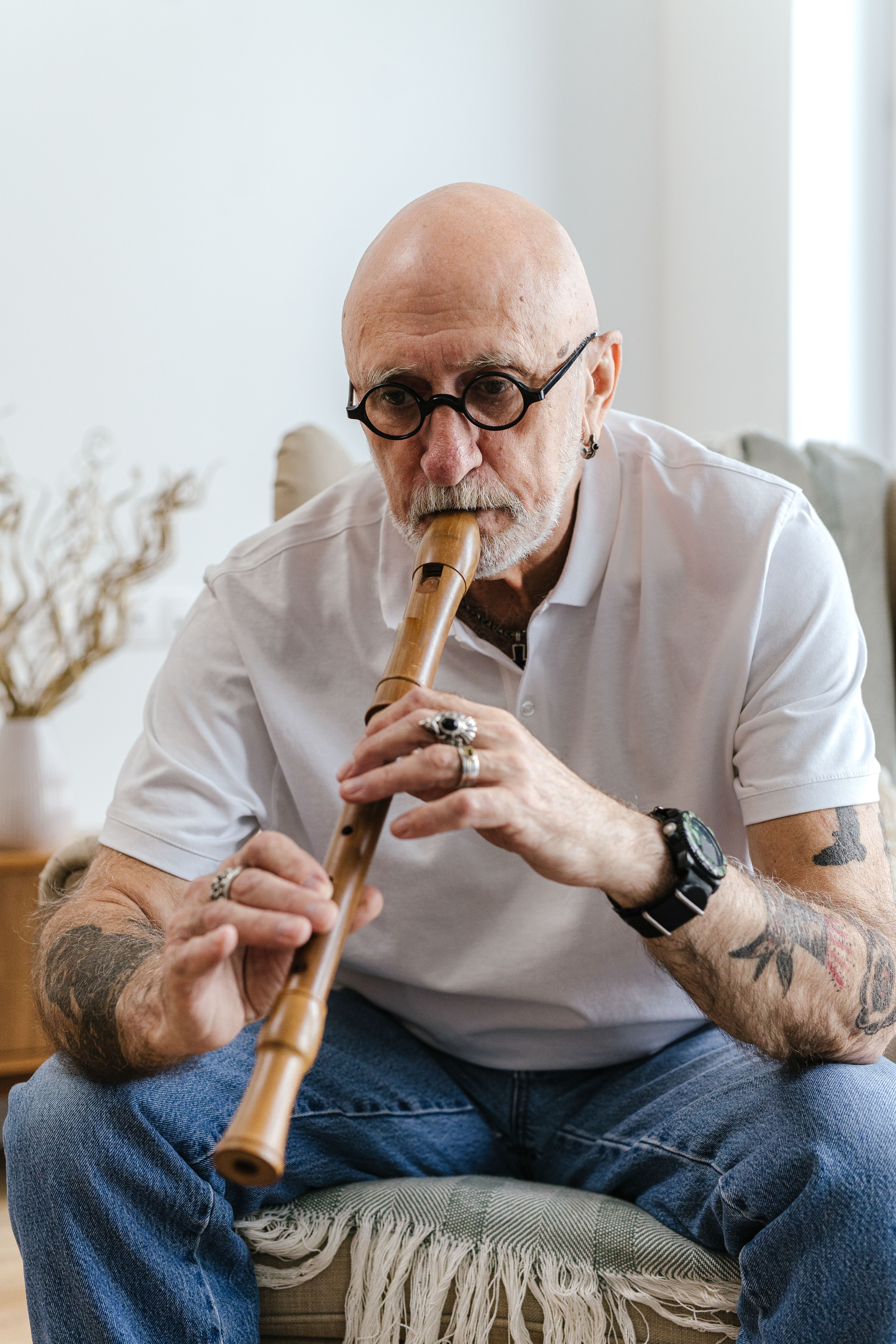 An Elderly Man Playing a Pan Flute · Free Stock Photo