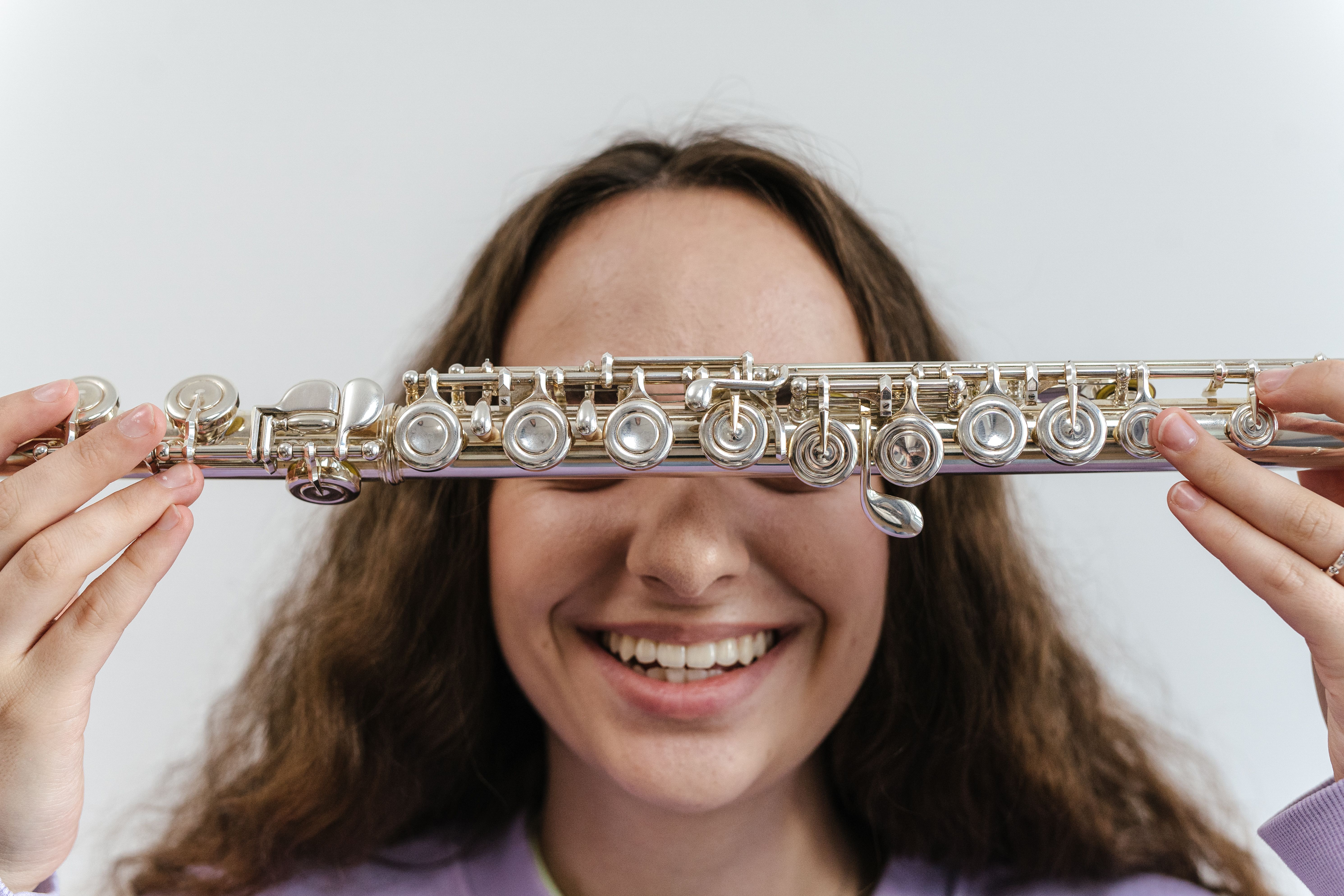 Woman Covering Her Face with Flute · Free Stock Photo