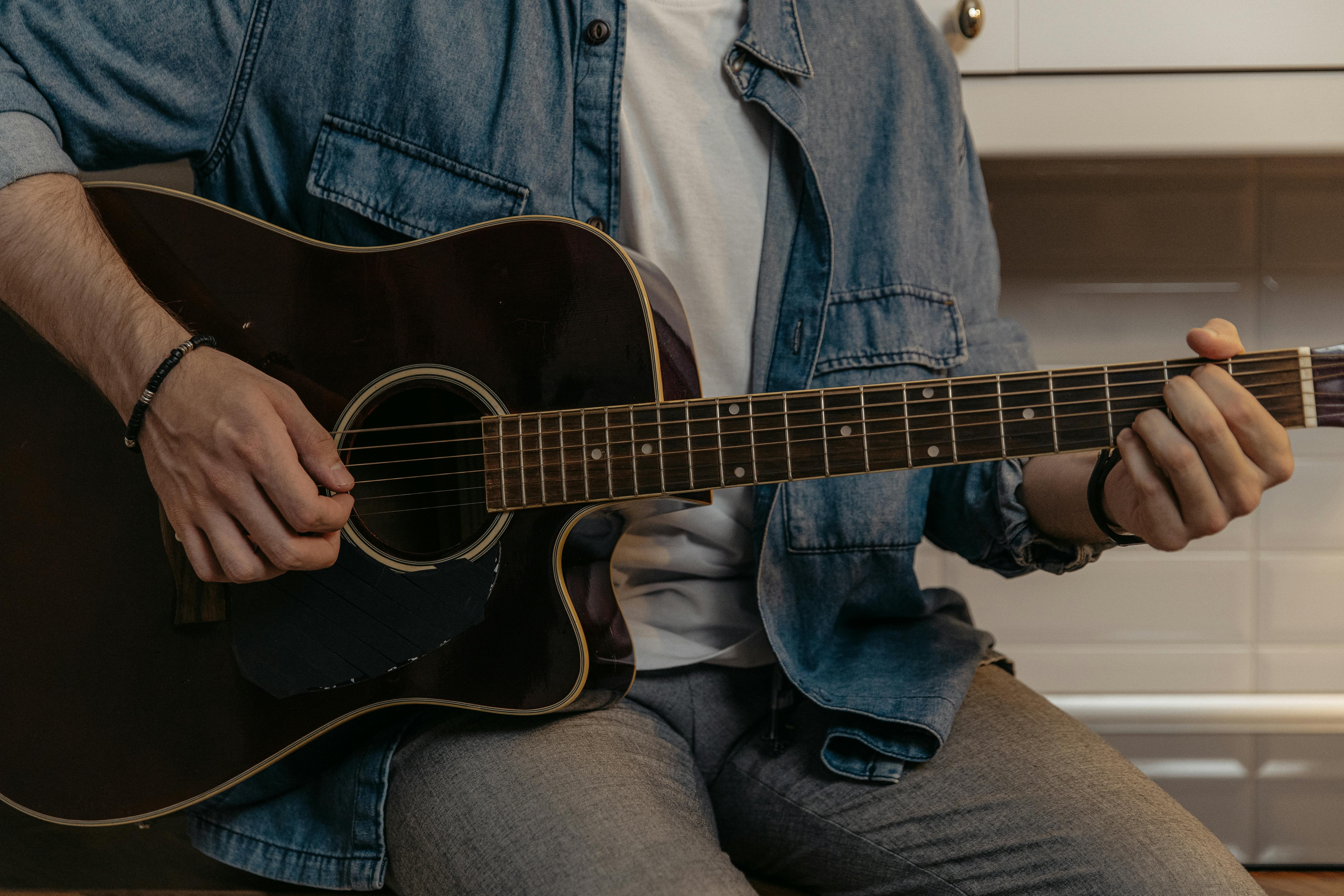 Person Playing Acoustic Guitar · Free Stock Photo
