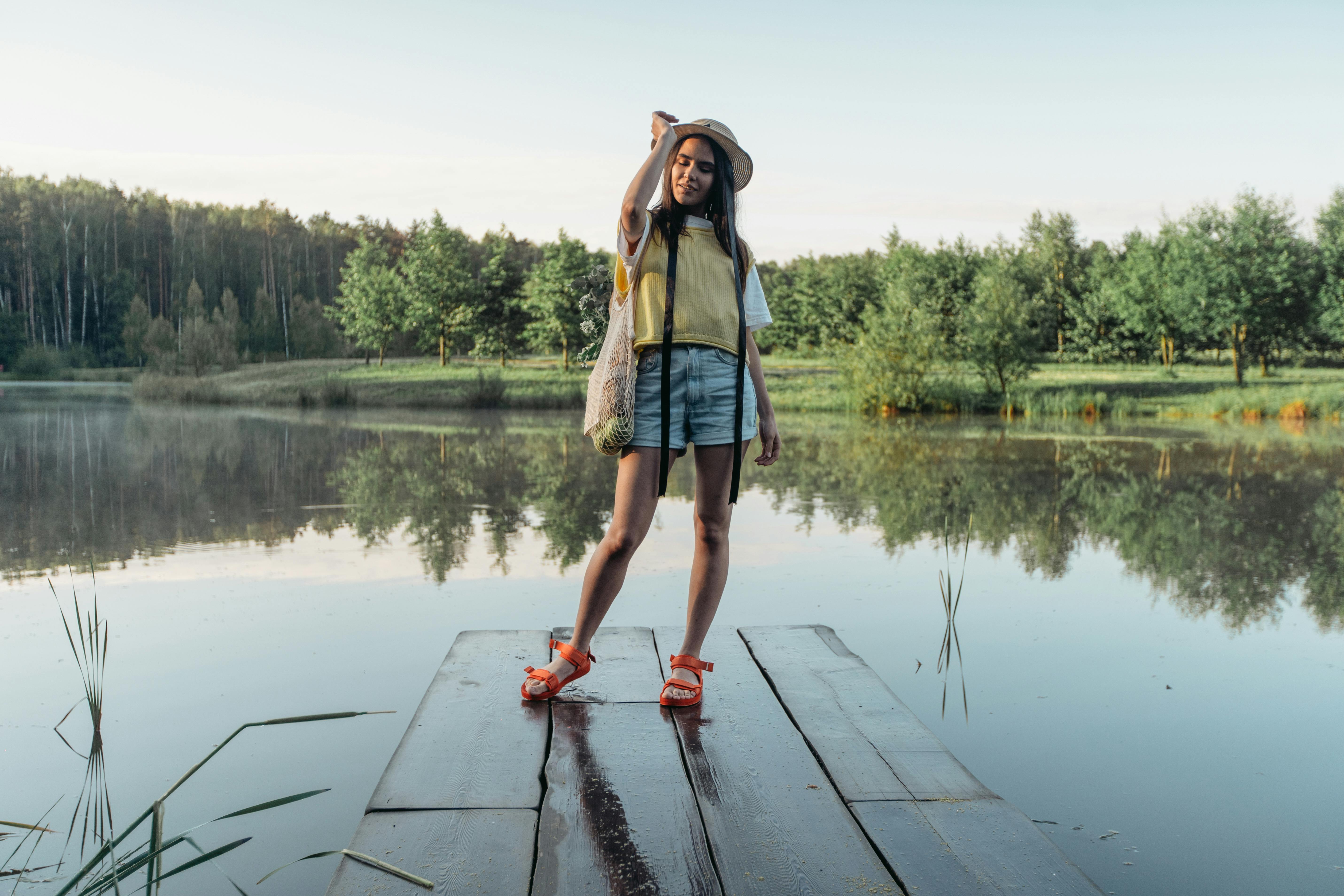 A Woman Standing on a Dock · Free Stock Photo