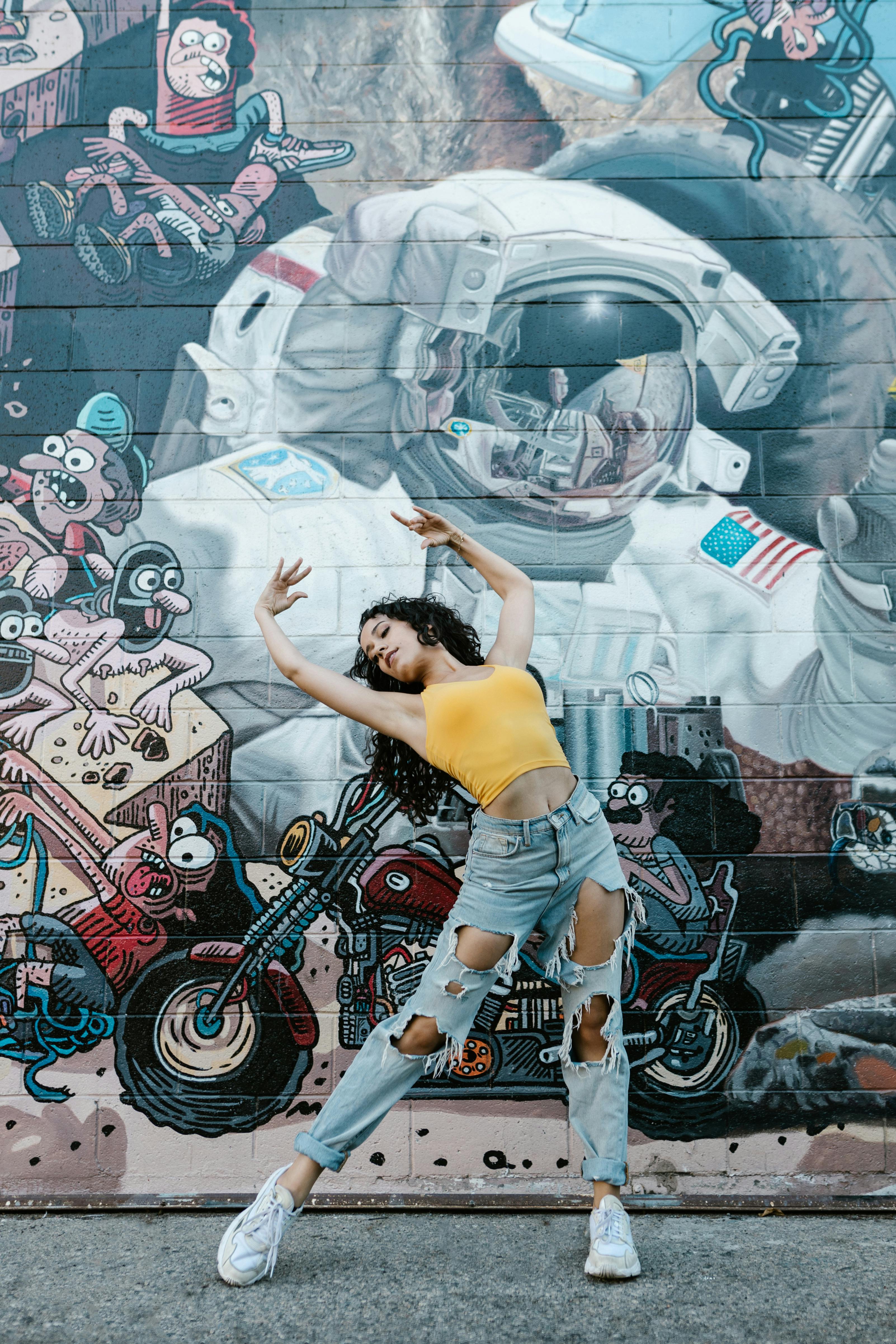 Woman in Yellow Tank Top and Blue Denim Shorts Dancing · Free Stock Photo