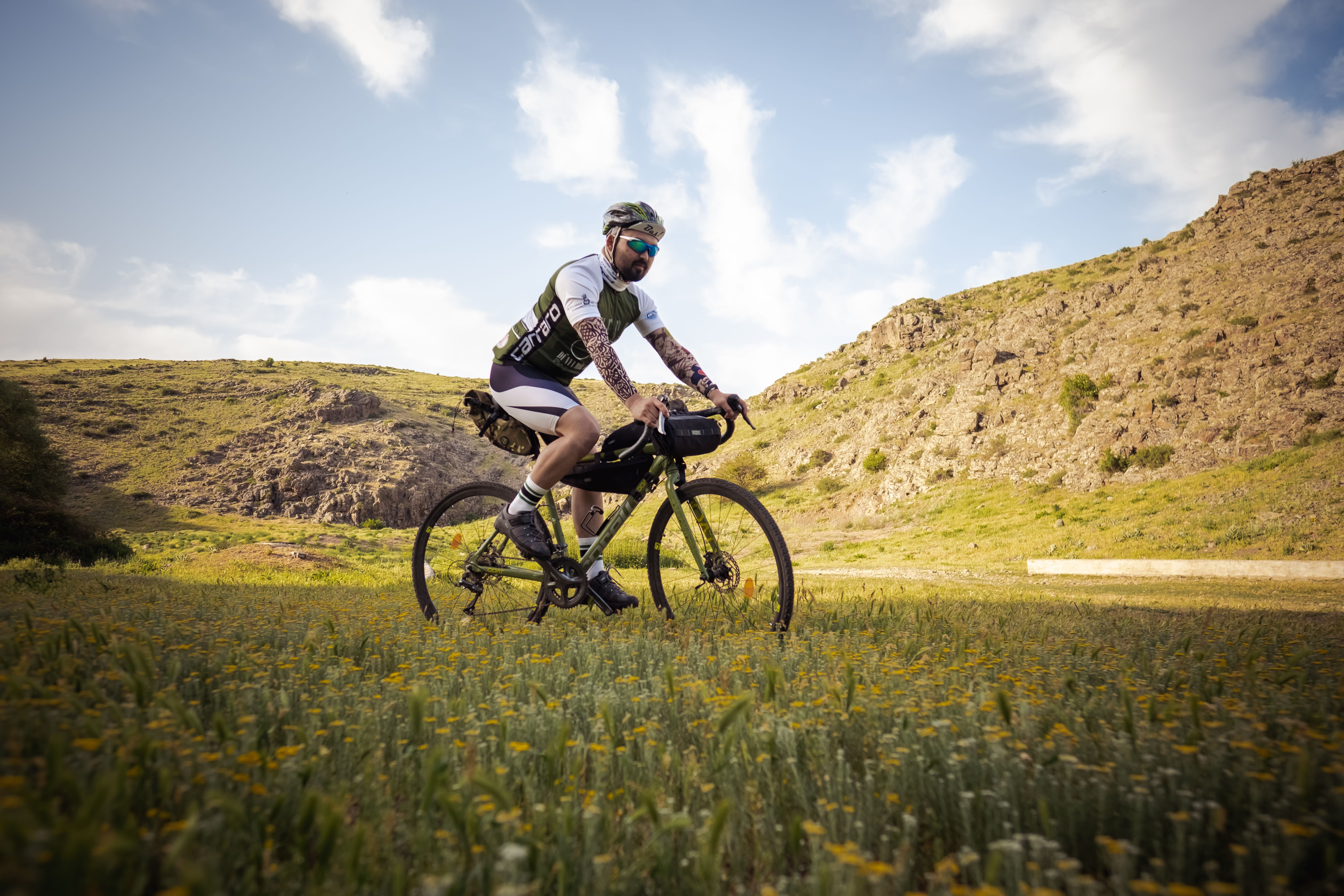 Man Riding a Bicycle by the Field · Free Stock Photo