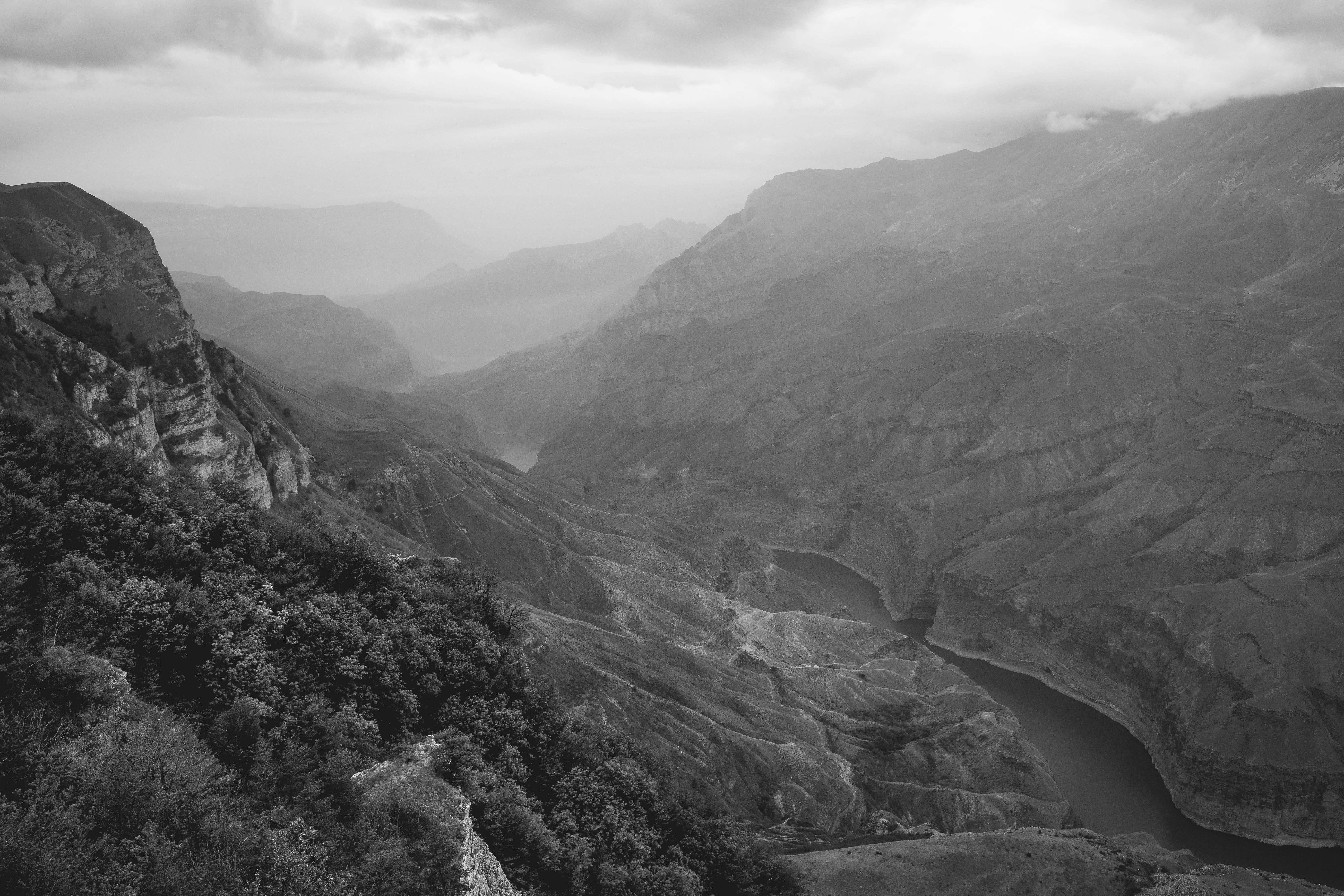 A Grayscale of a River Between Mountains · Free Stock Photo