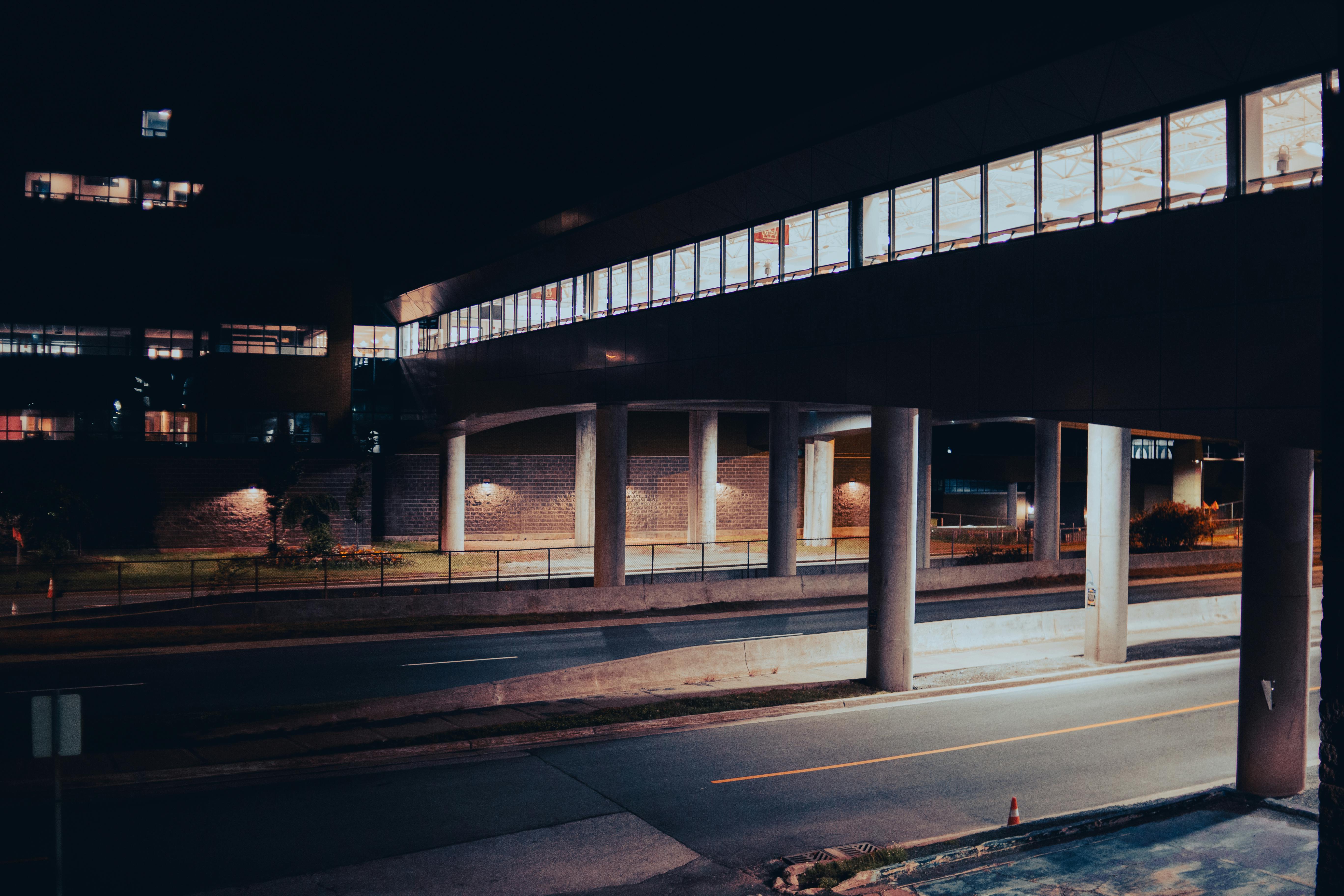 An Enclosed Footbridge Over a Road at Night · Free Stock Photo