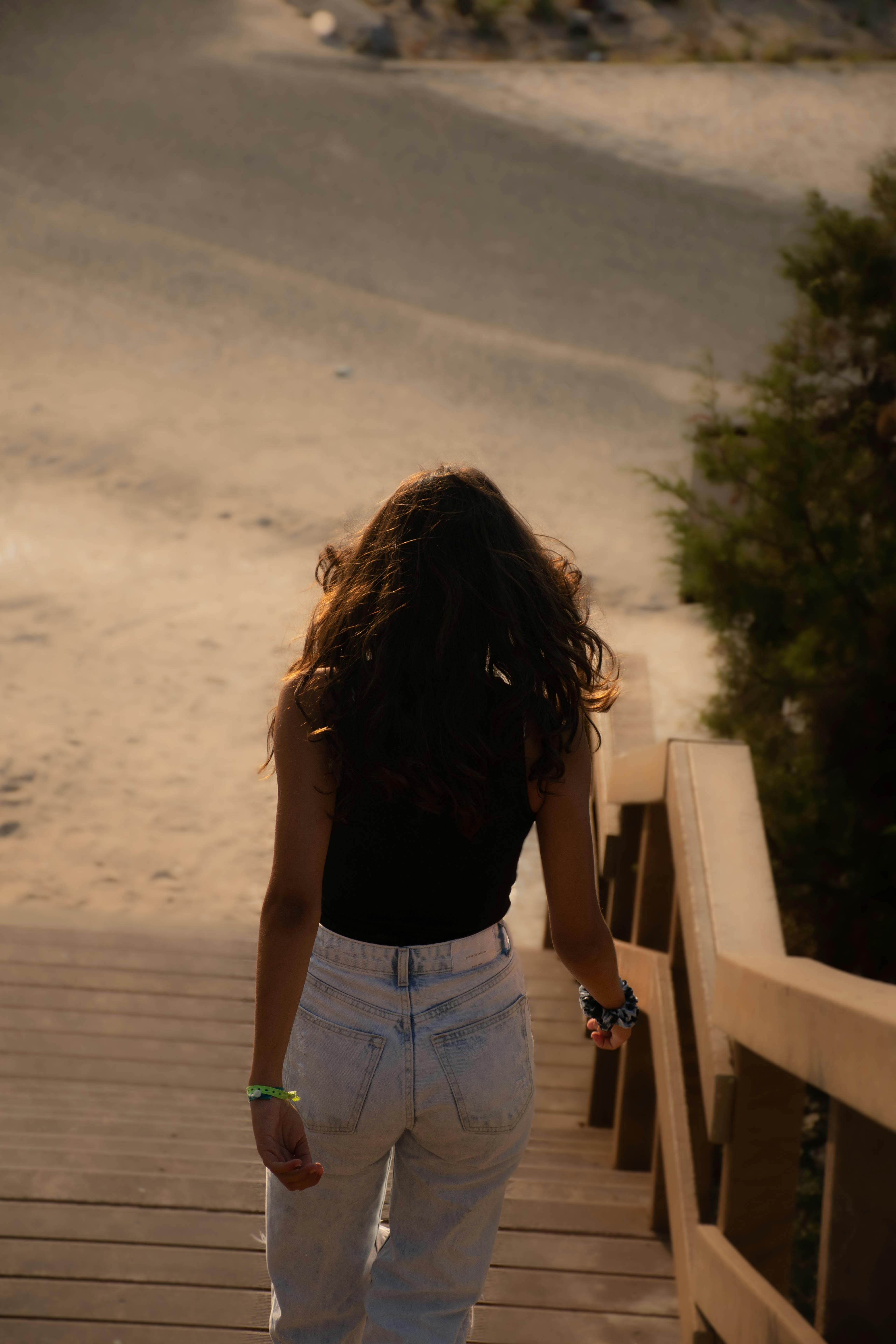 Back View of a Woman Reading a Book · Free Stock Photo