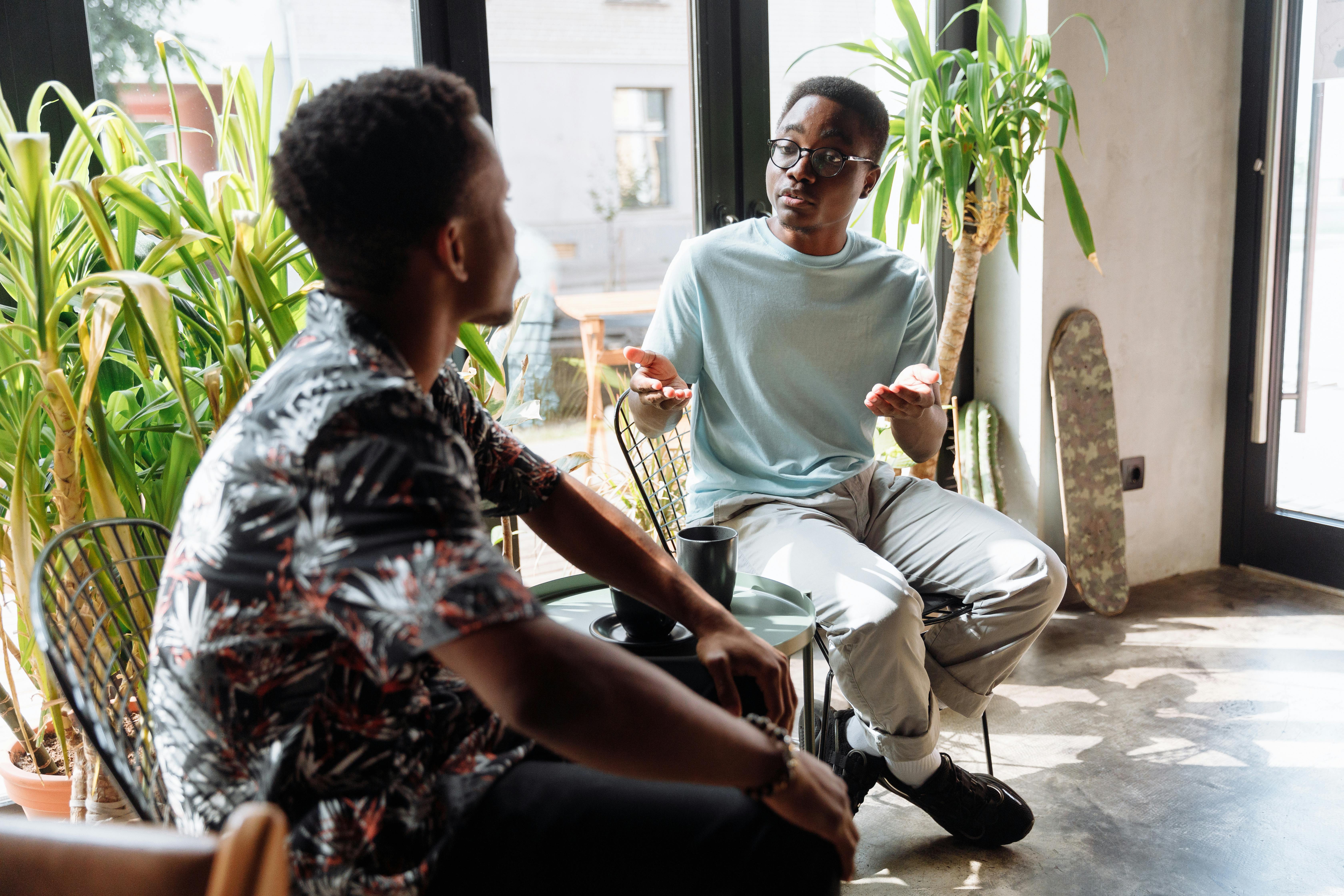 Men Having Coffee Beside a Window · Free Stock Photo