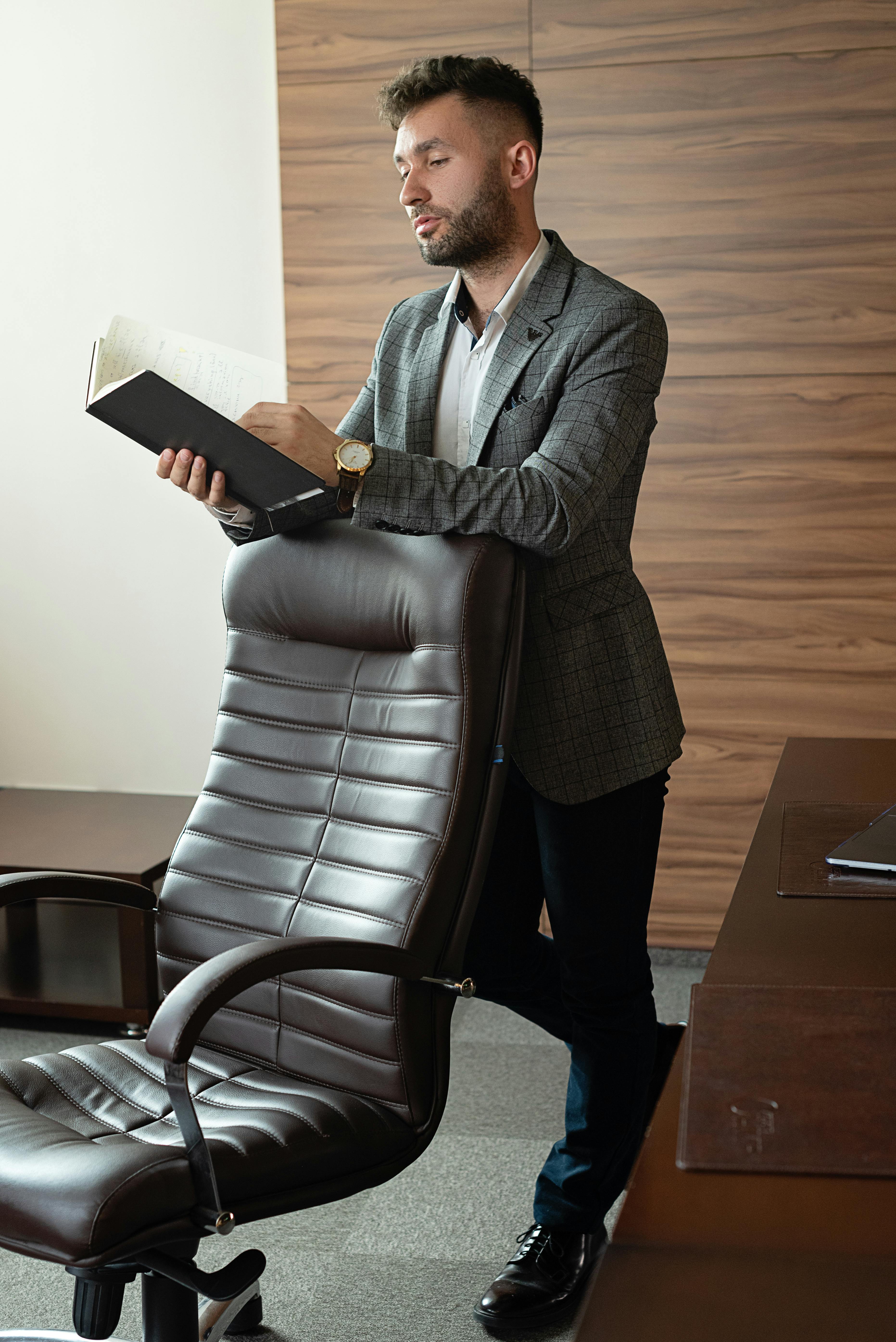 Man Leaning on a Office Chair · Free Stock Photo