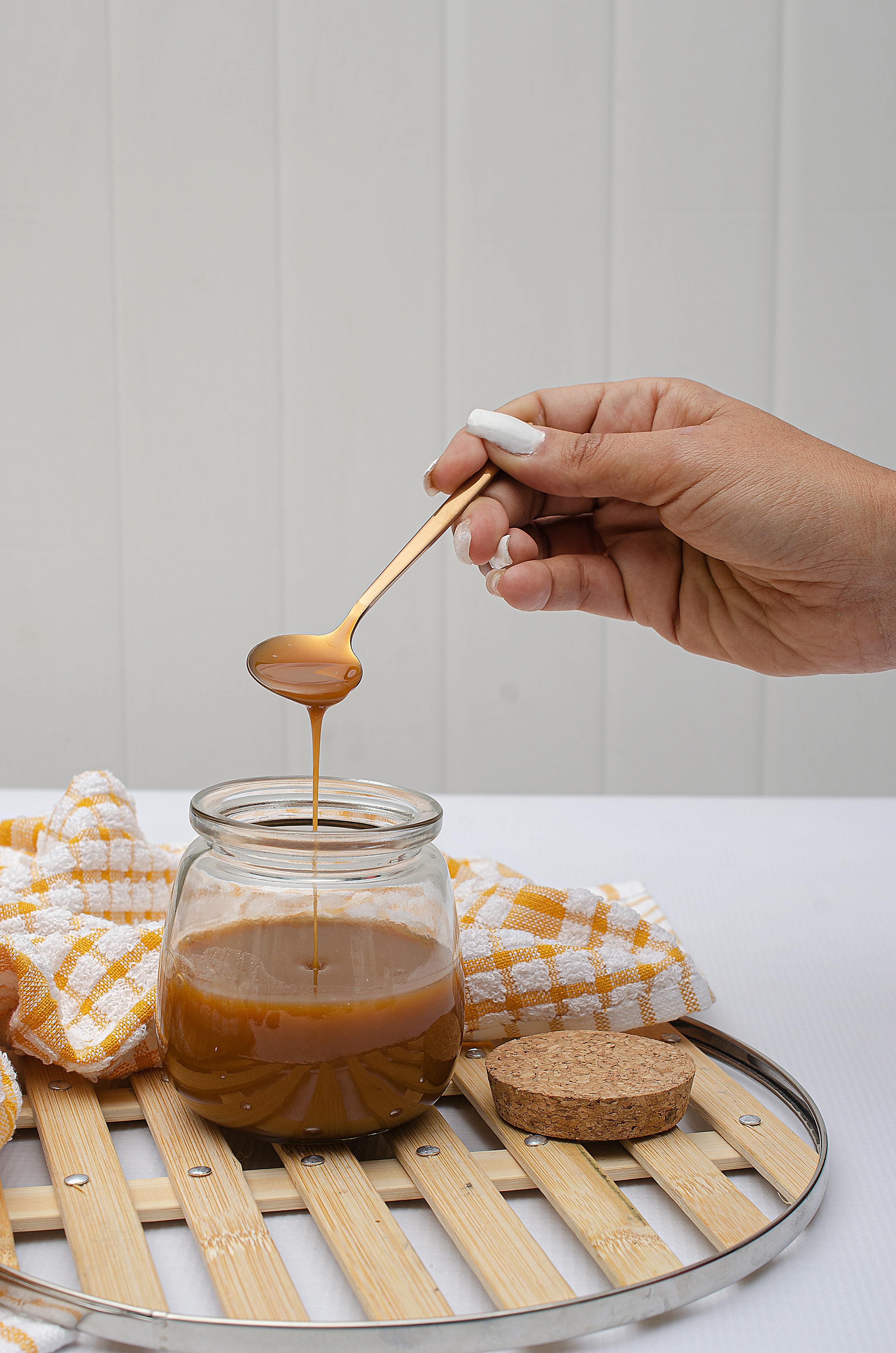 A Person Scooping Honey with a Spoon · Free Stock Photo