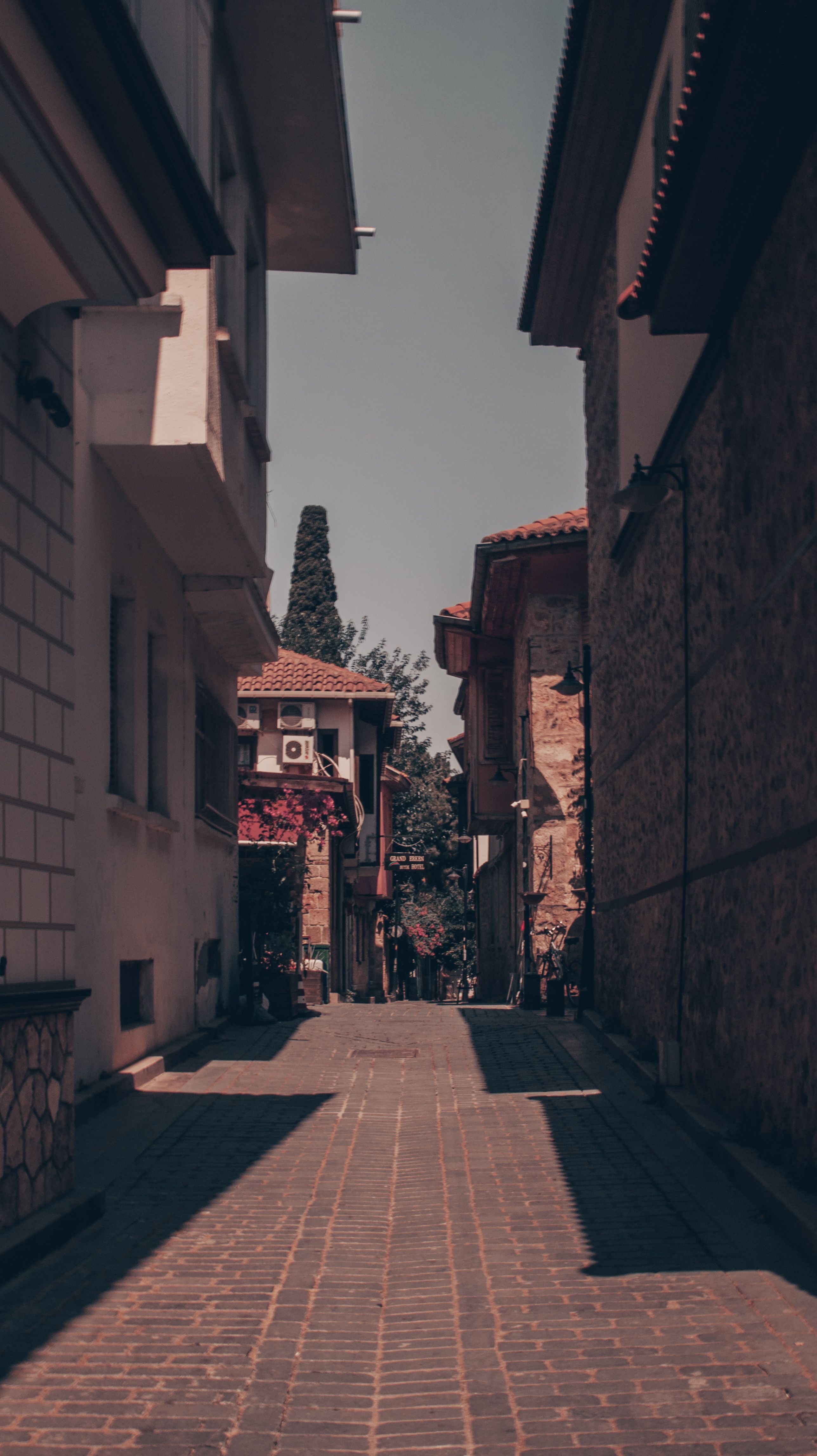 A Narrow Alley Between Concrete Houses · Free Stock Photo