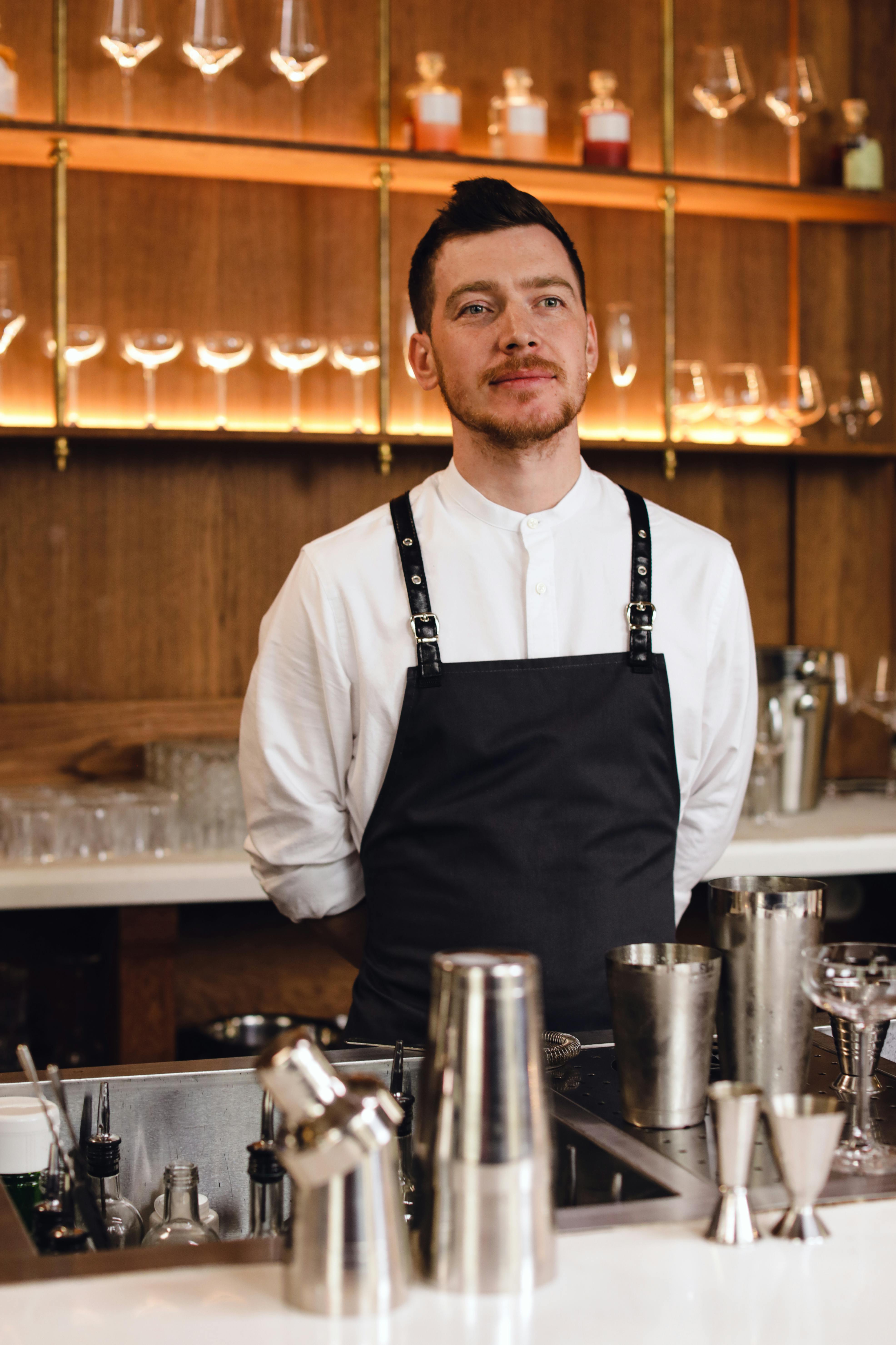 Bartender Standing Behind a bar · Free Stock Photo