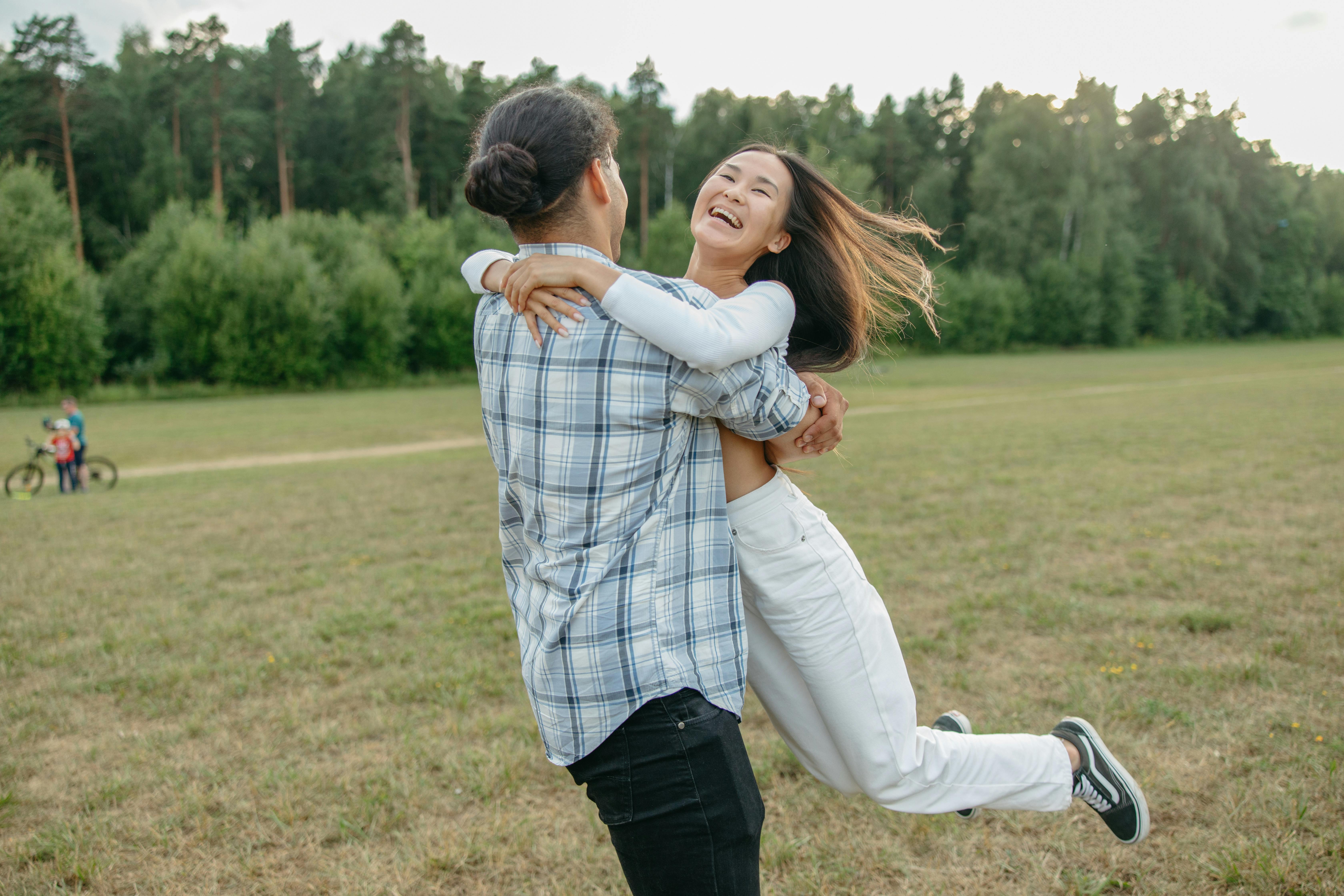 A Happy Woman Carried by Her Partner · Free Stock Photo