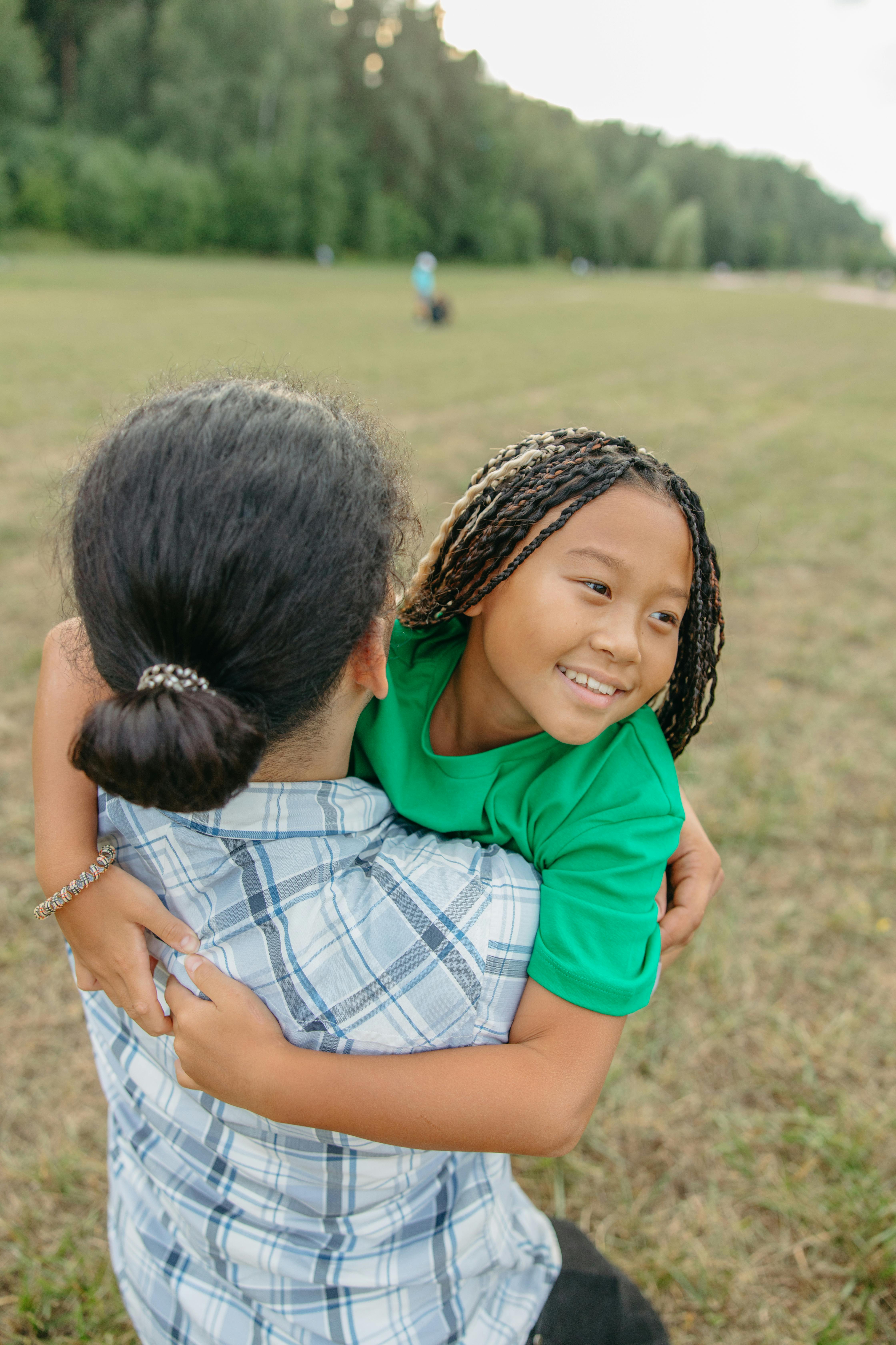 A Young Girl Being Carried at the Park · Free Stock Photo
