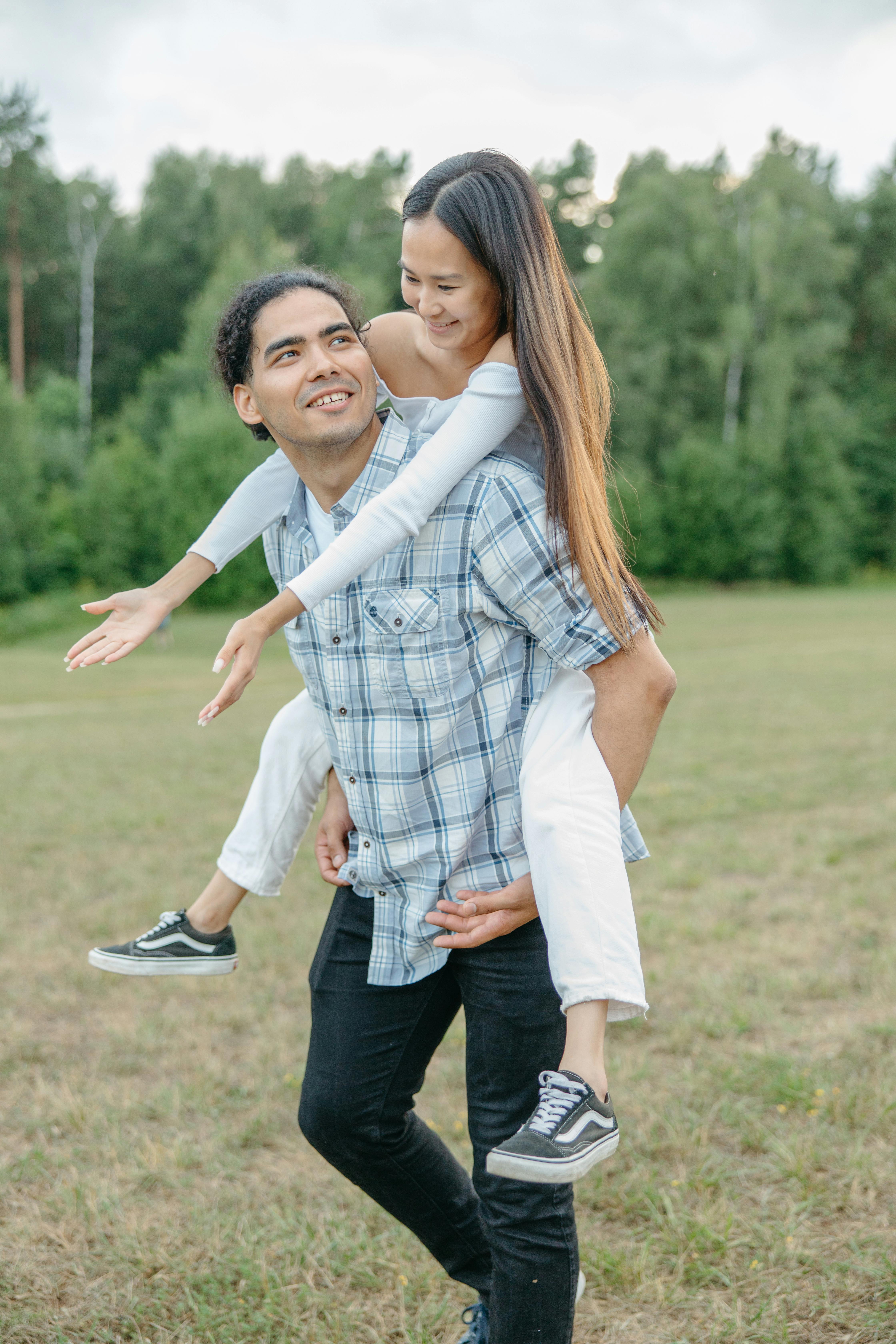 Photo of a Woman Riding a Man's Back · Free Stock Photo