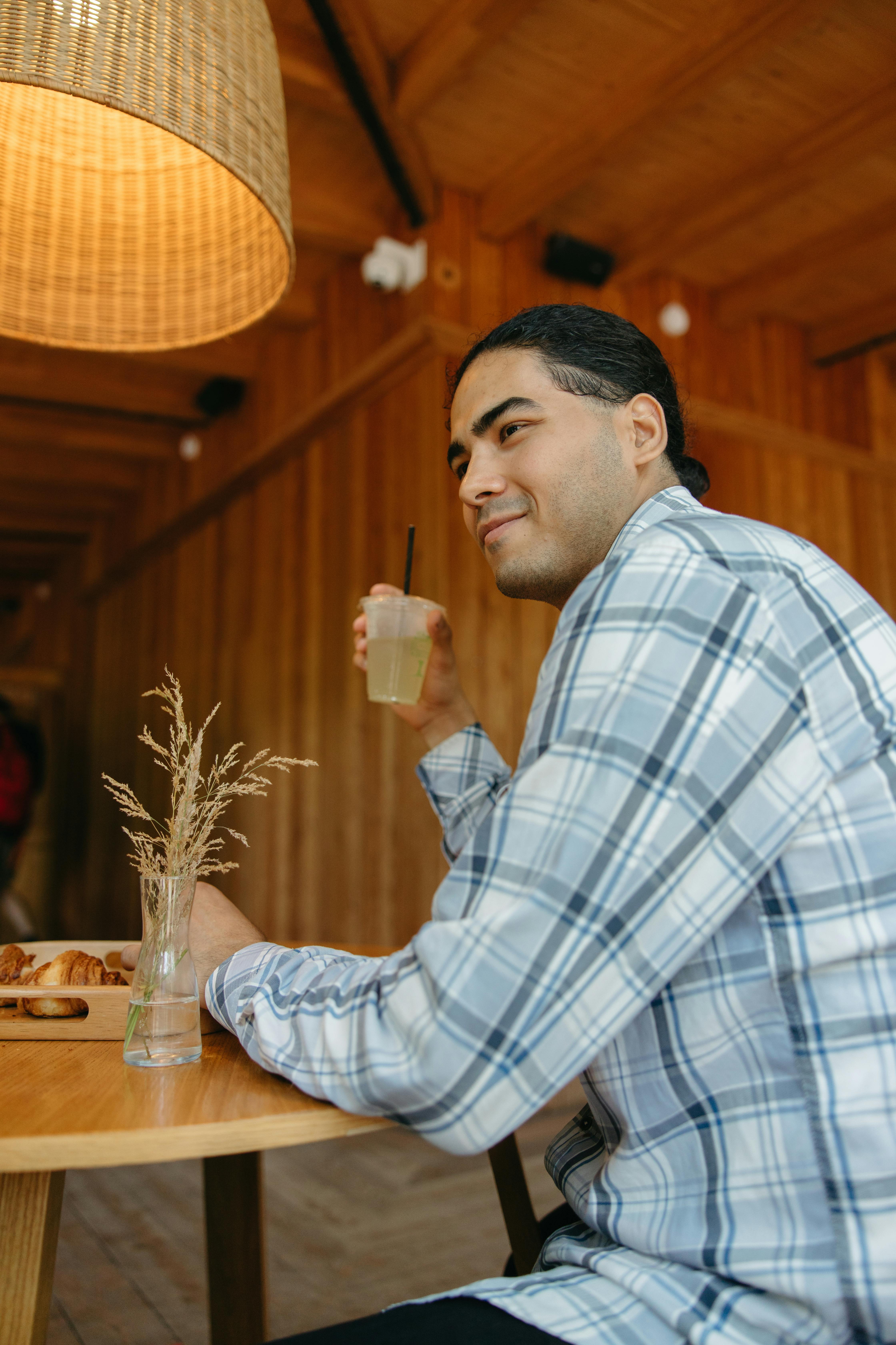 Man Drinking Lemonade in a Restaurant · Free Stock Photo