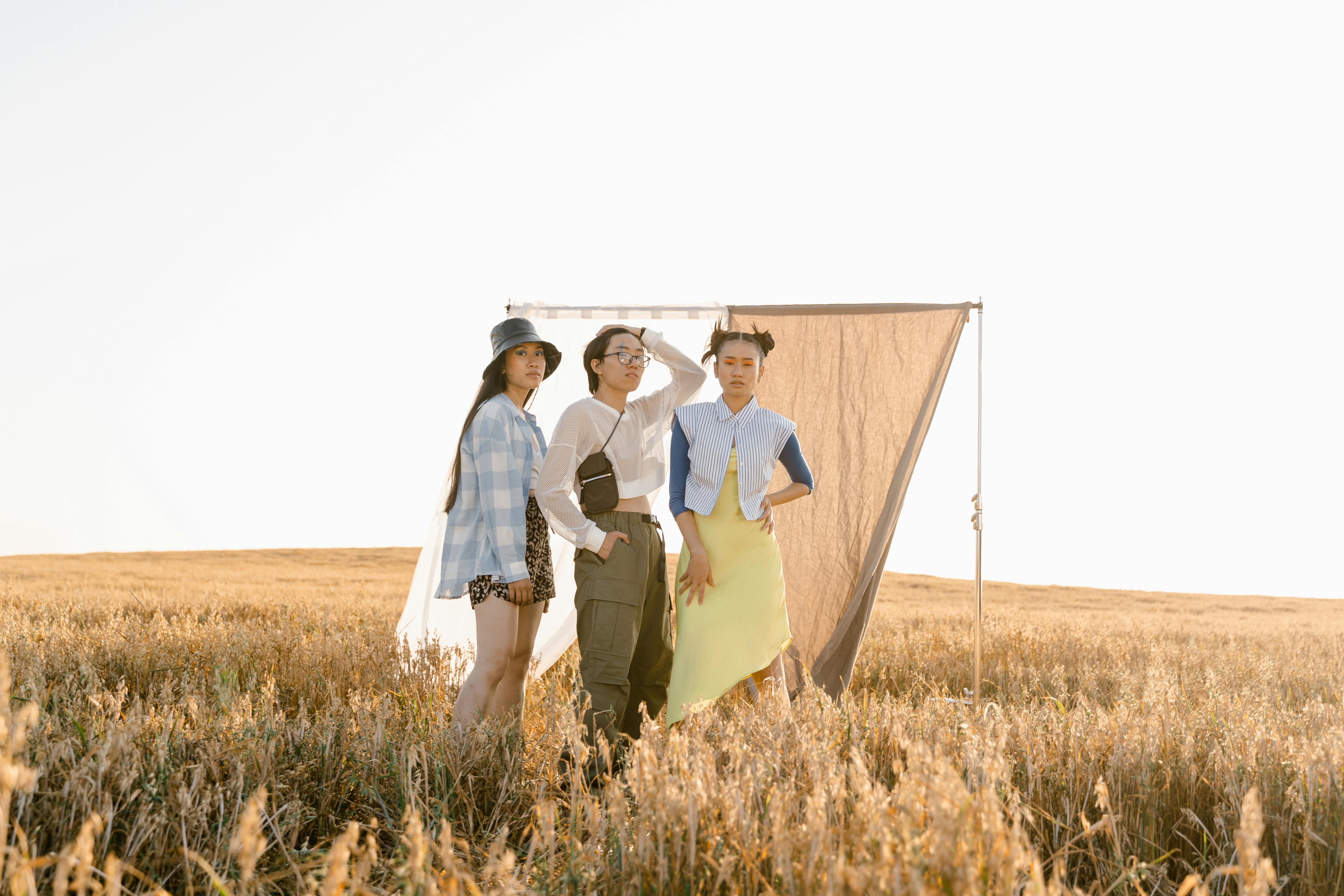Models Posing on Grass Field · Free Stock Photo