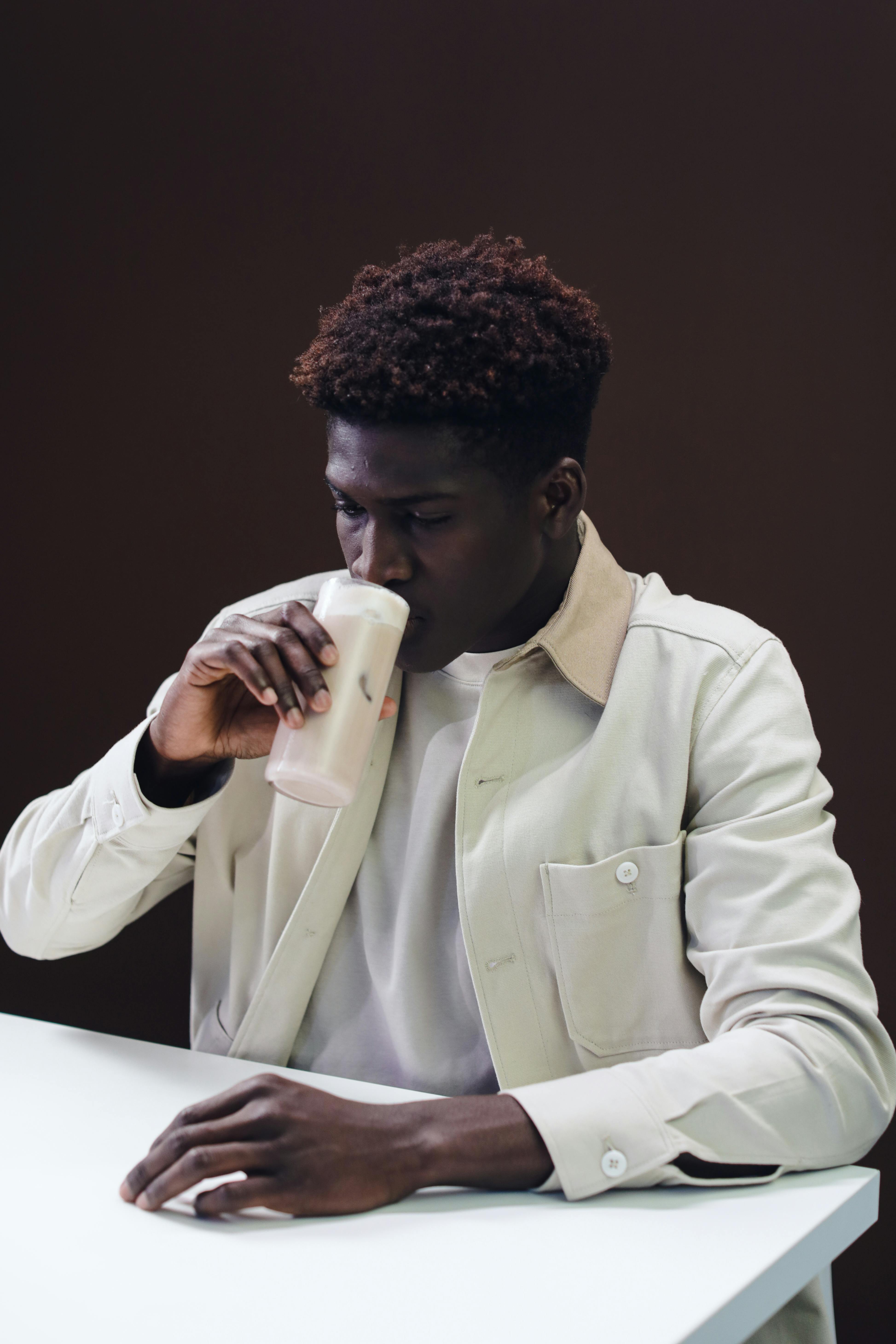 Man Drinking Juice on Pink Studio Background · Free Stock Photo