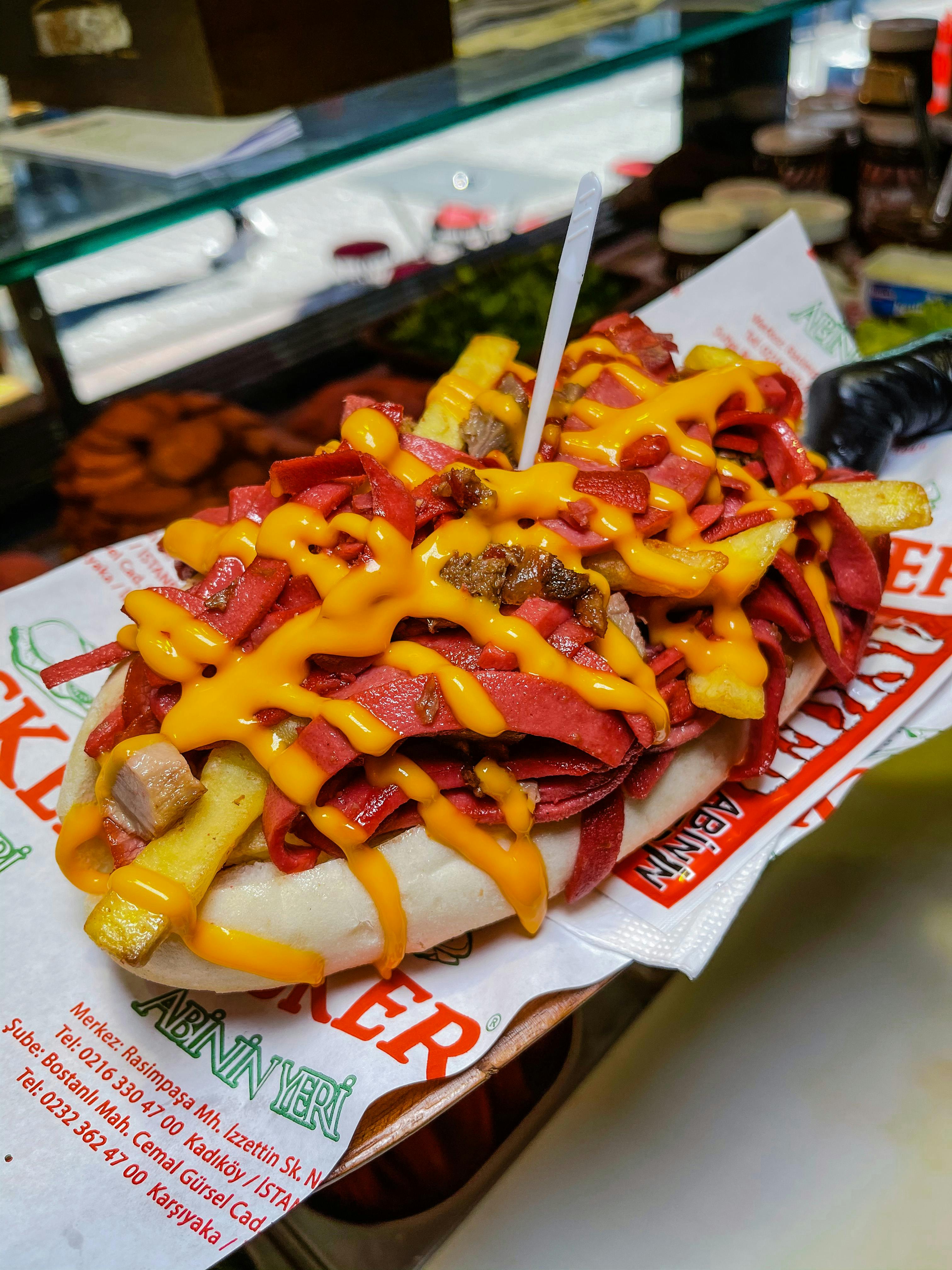 Big Hot Dog with a Lot of Topping and Sauces · Free Stock Photo