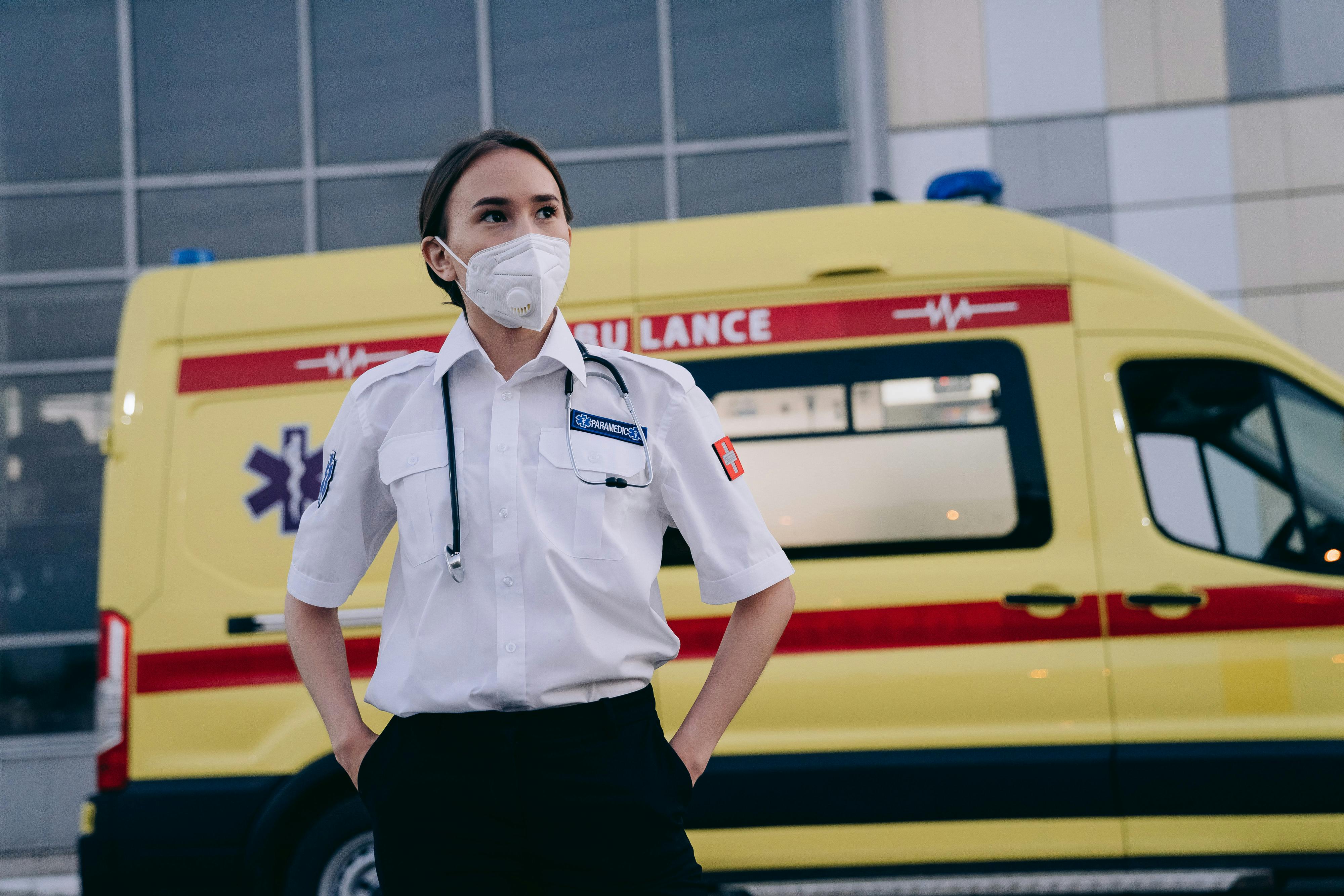 A Paramedic Standing in Front of an Ambulance · Free Stock Photo