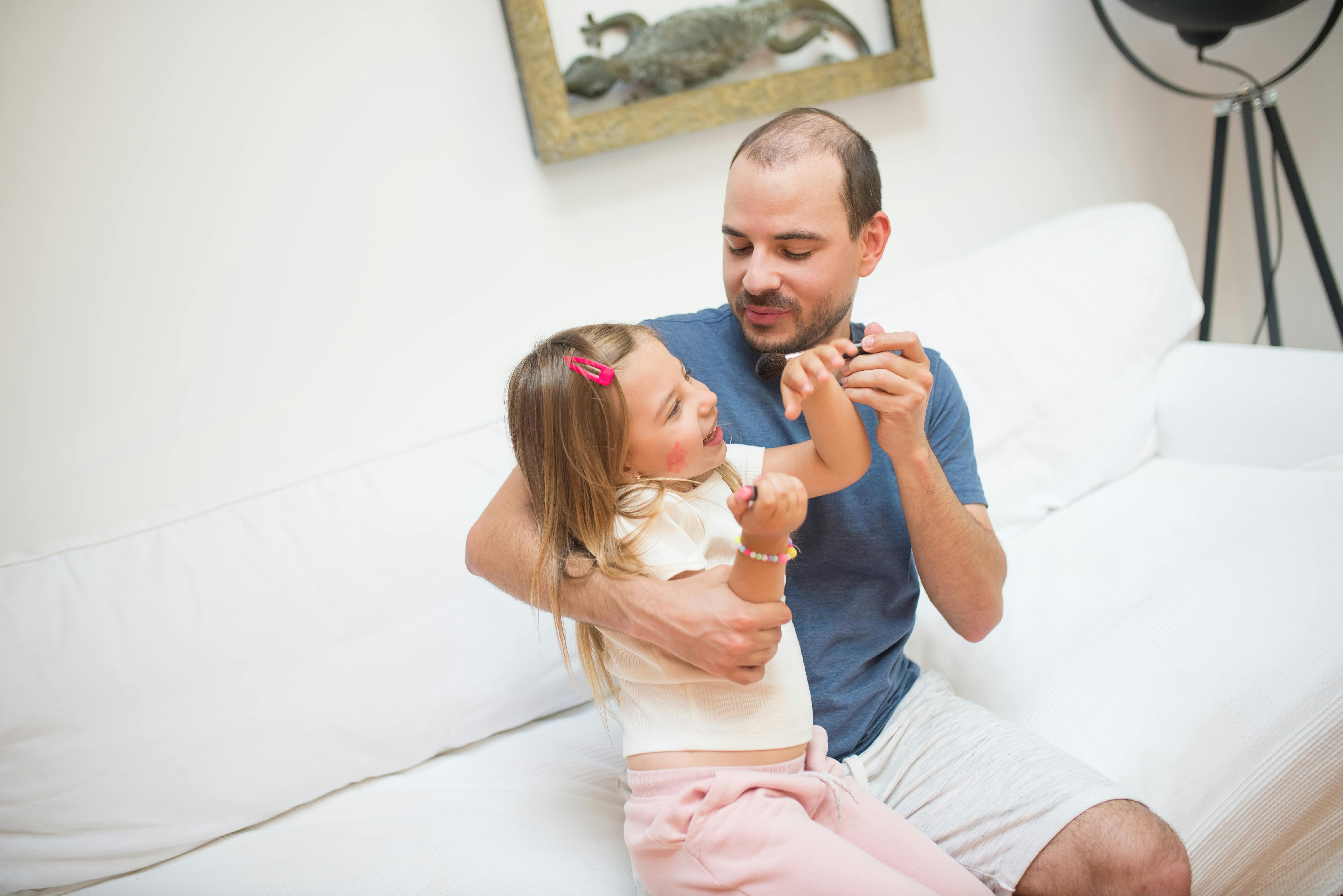 Father and Daughter Playing with a Mop in Living Room · Free Stock Photo
