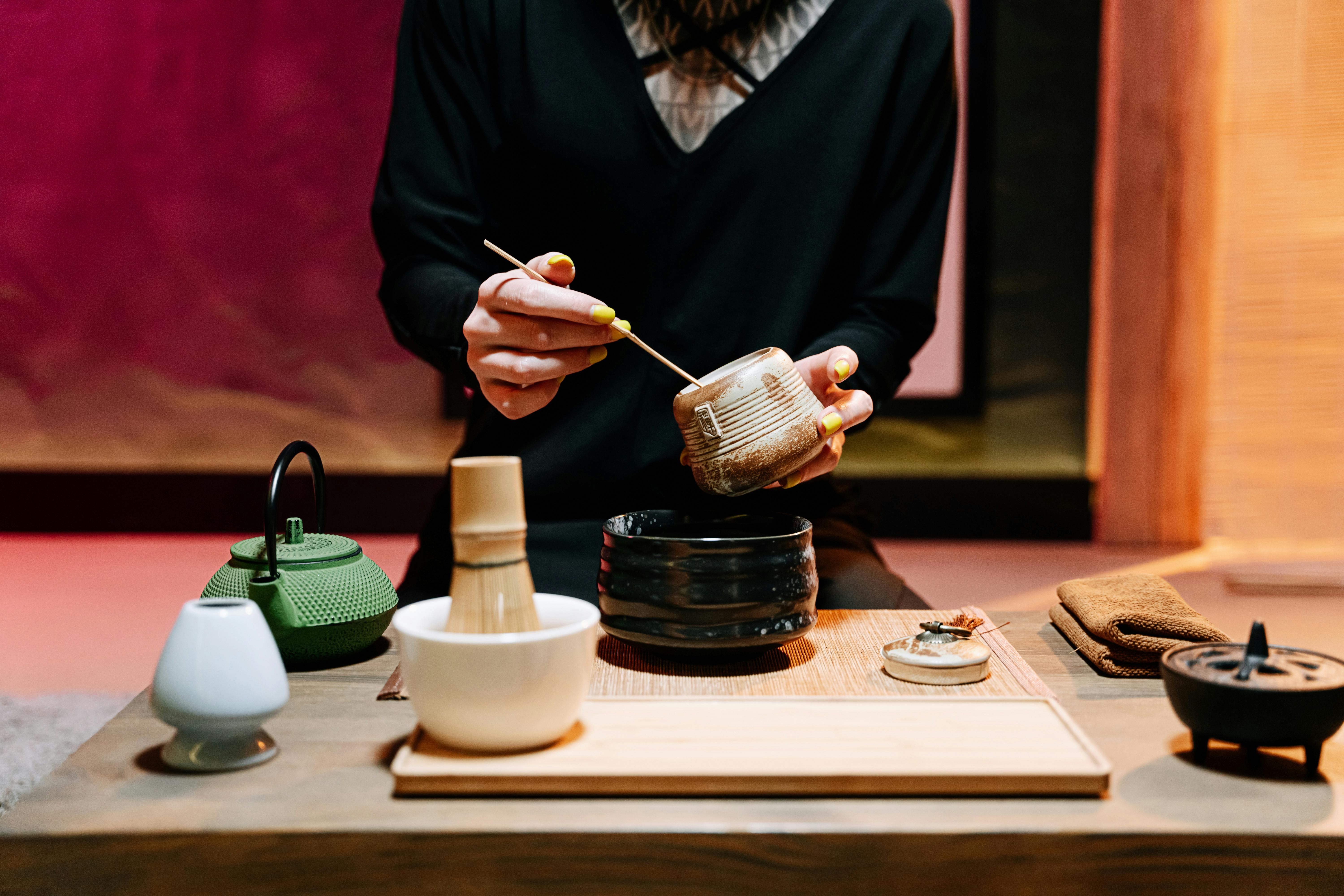 Person preparing tea in bowl for tea ceremony · Free Stock Photo