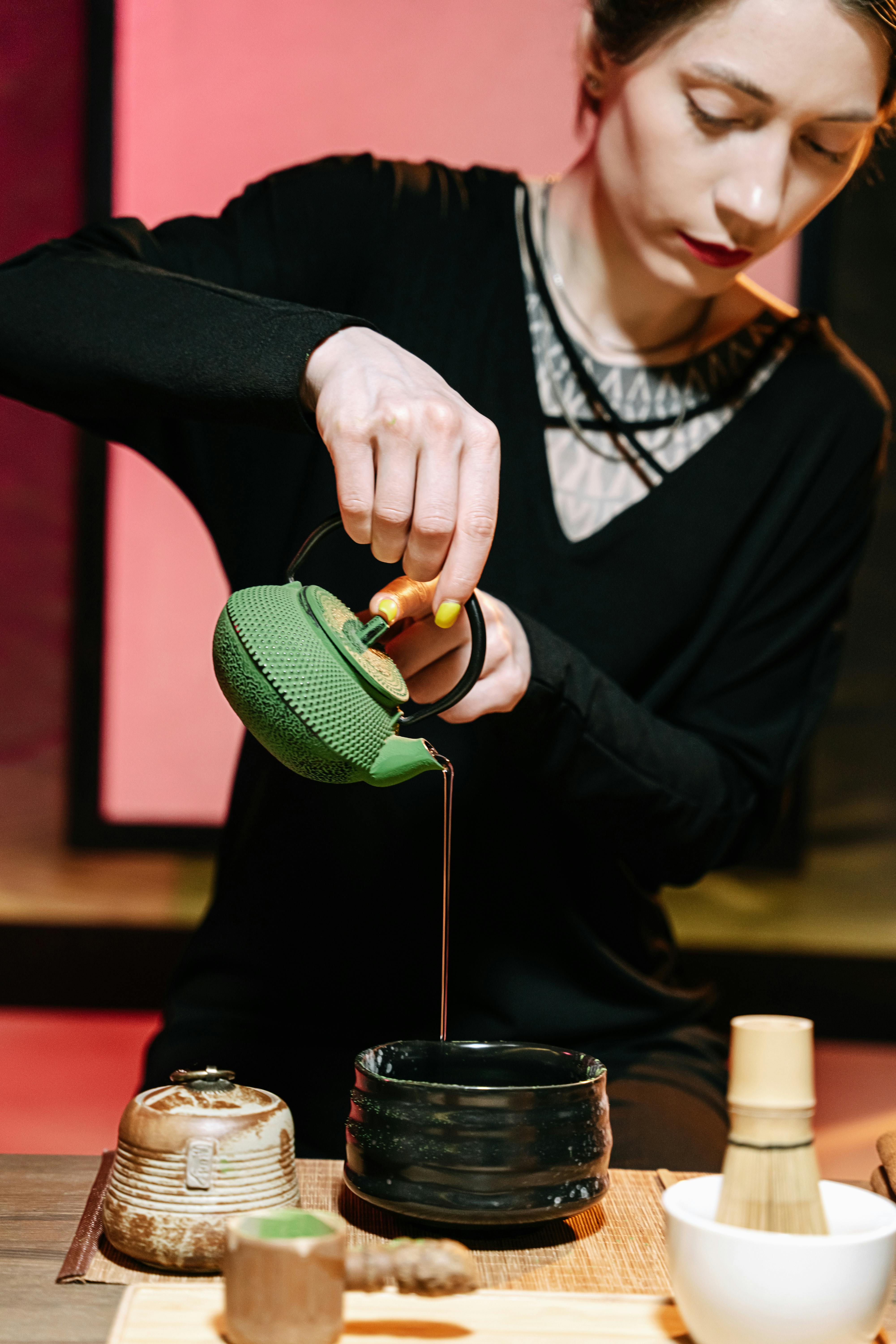 Woman in Black Long Sleeve Shirt Pouring Tea · Free Stock Photo