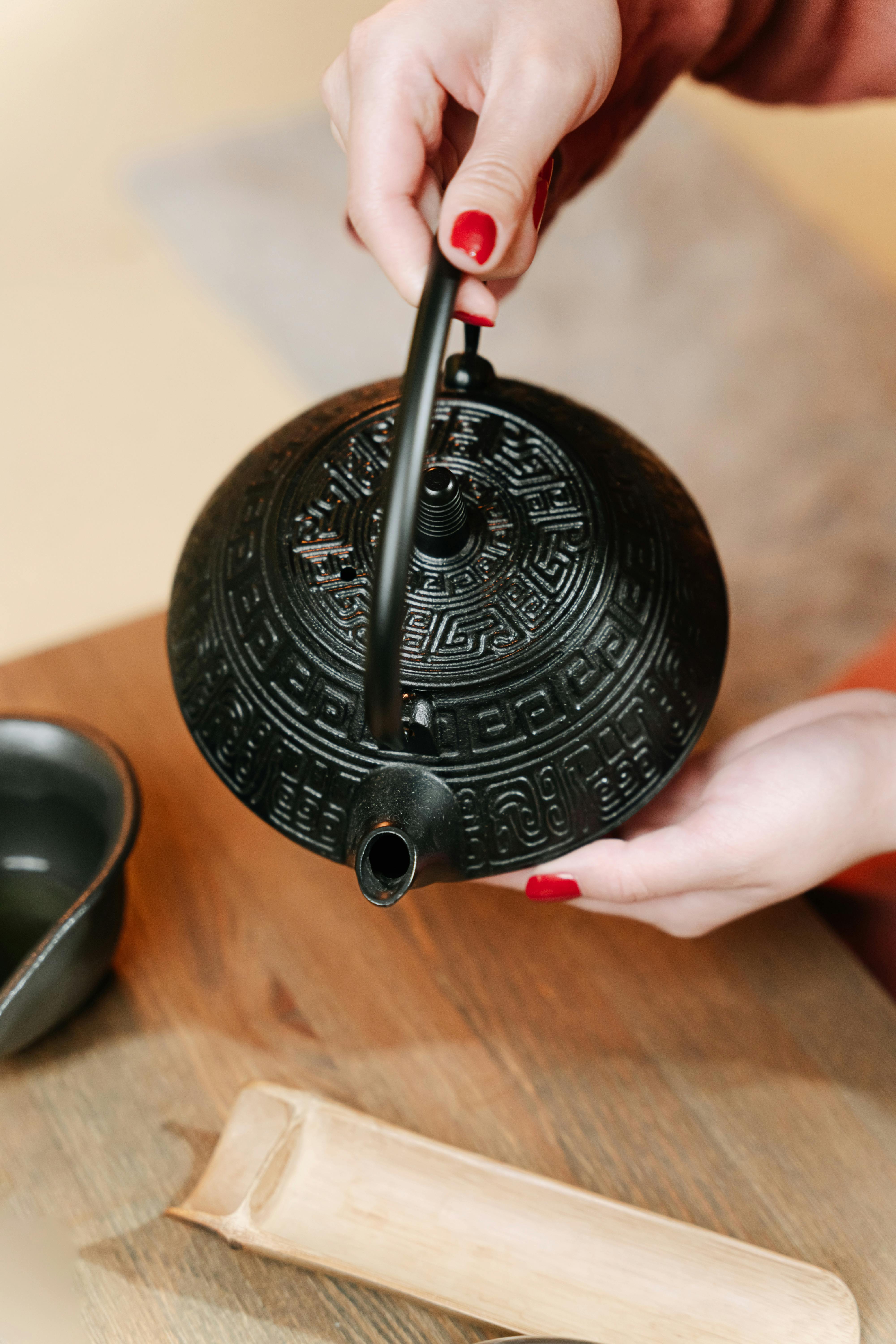 Person Holding a Teapot · Free Stock Photo