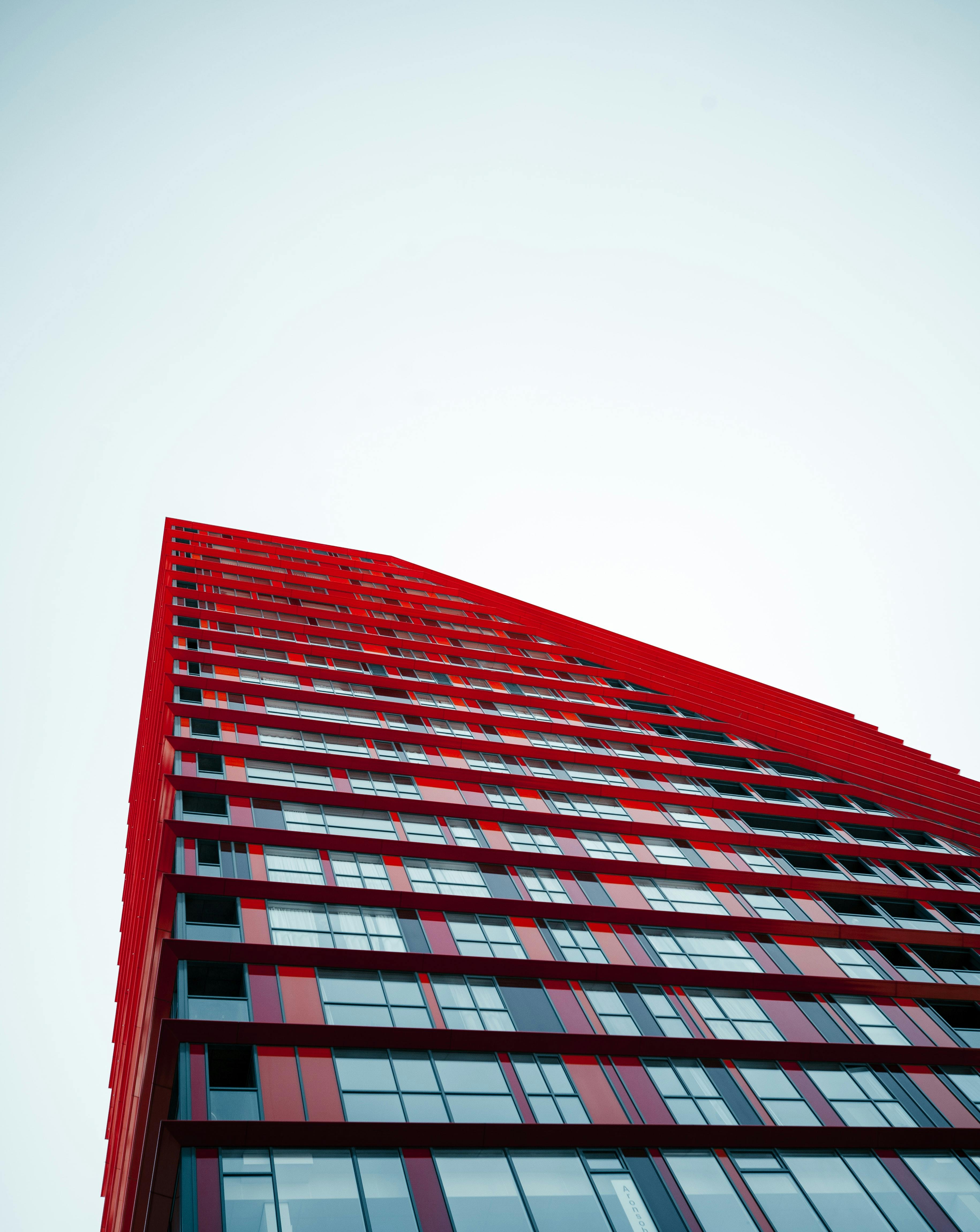 Low Angle Shot of a Red High-Rise Building · Free Stock Photo