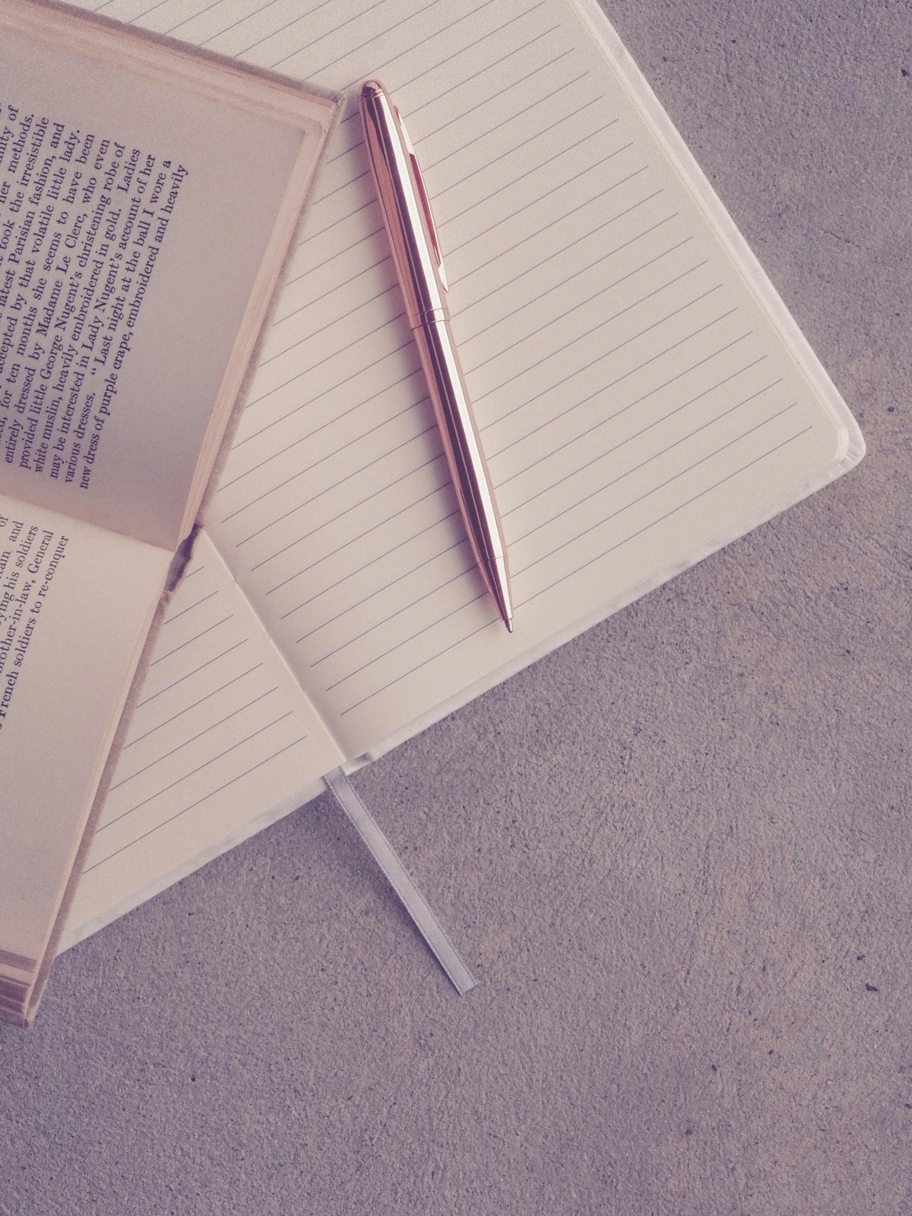 Book and Pen on Notebook · Free Stock Photo